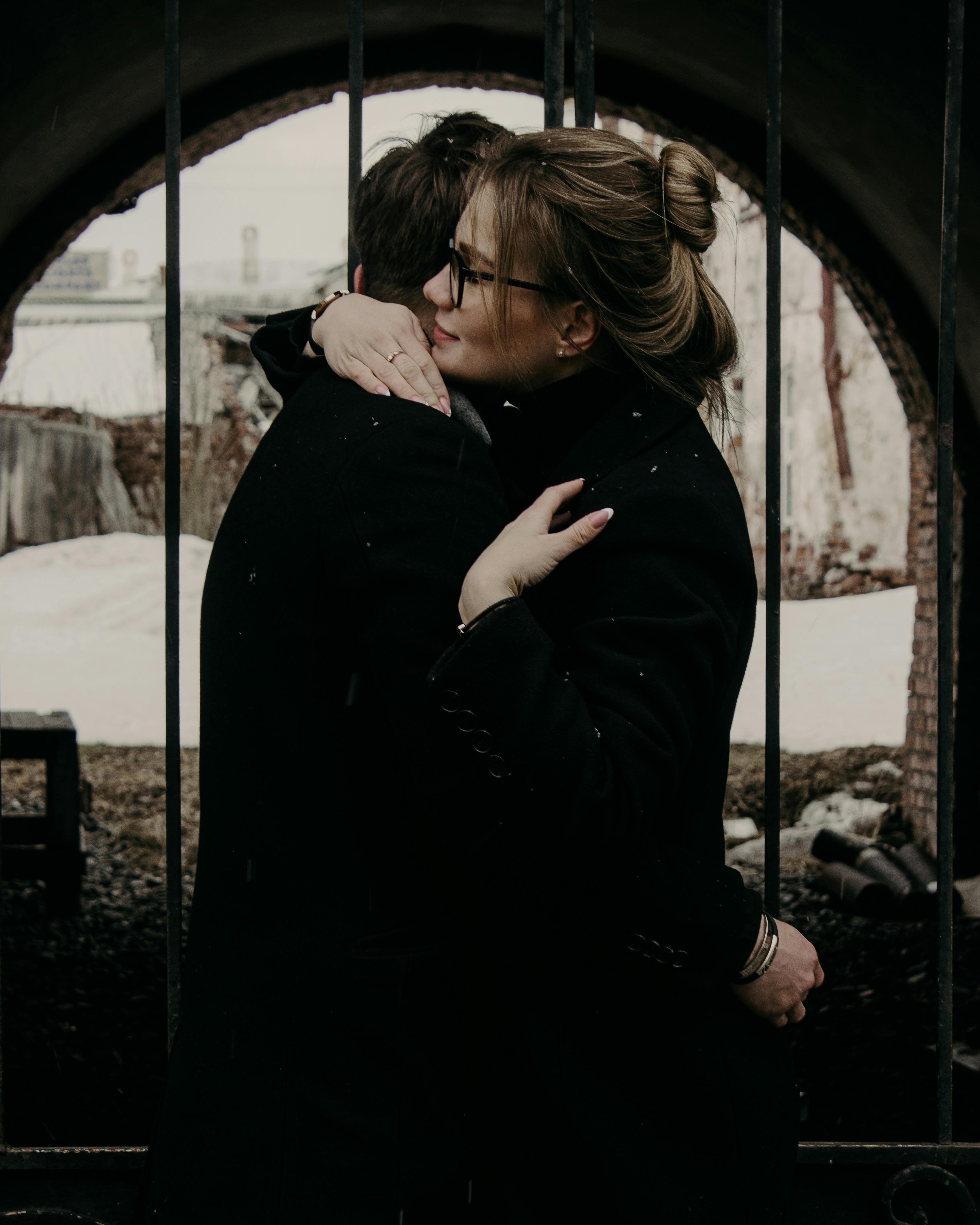 Woman and Man Cuddle on Field · Free Stock Photo