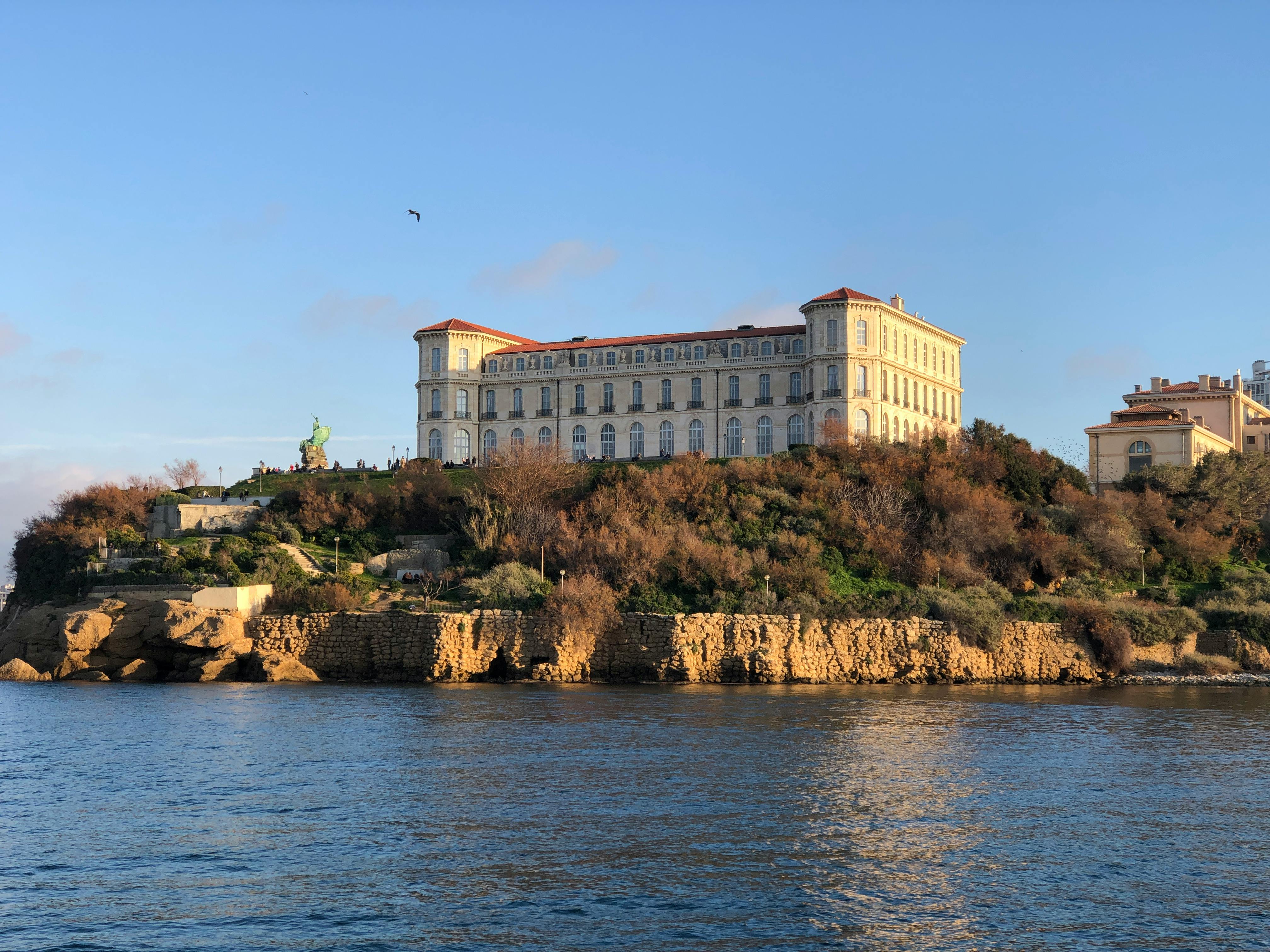 Palais Du Pharo near Body of Water · Free Stock Photo