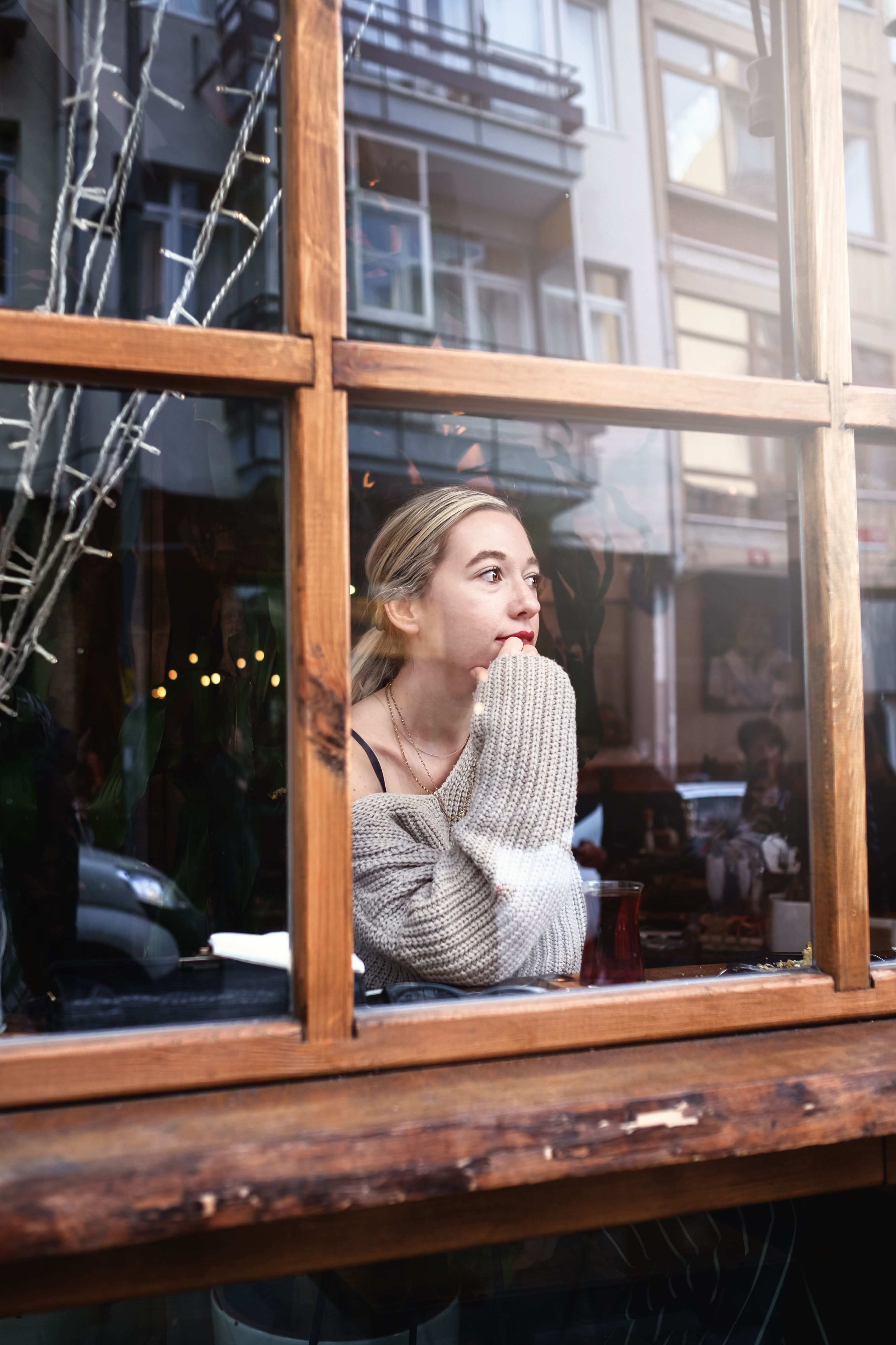 Woman By a Glass Window · Free Stock Photo