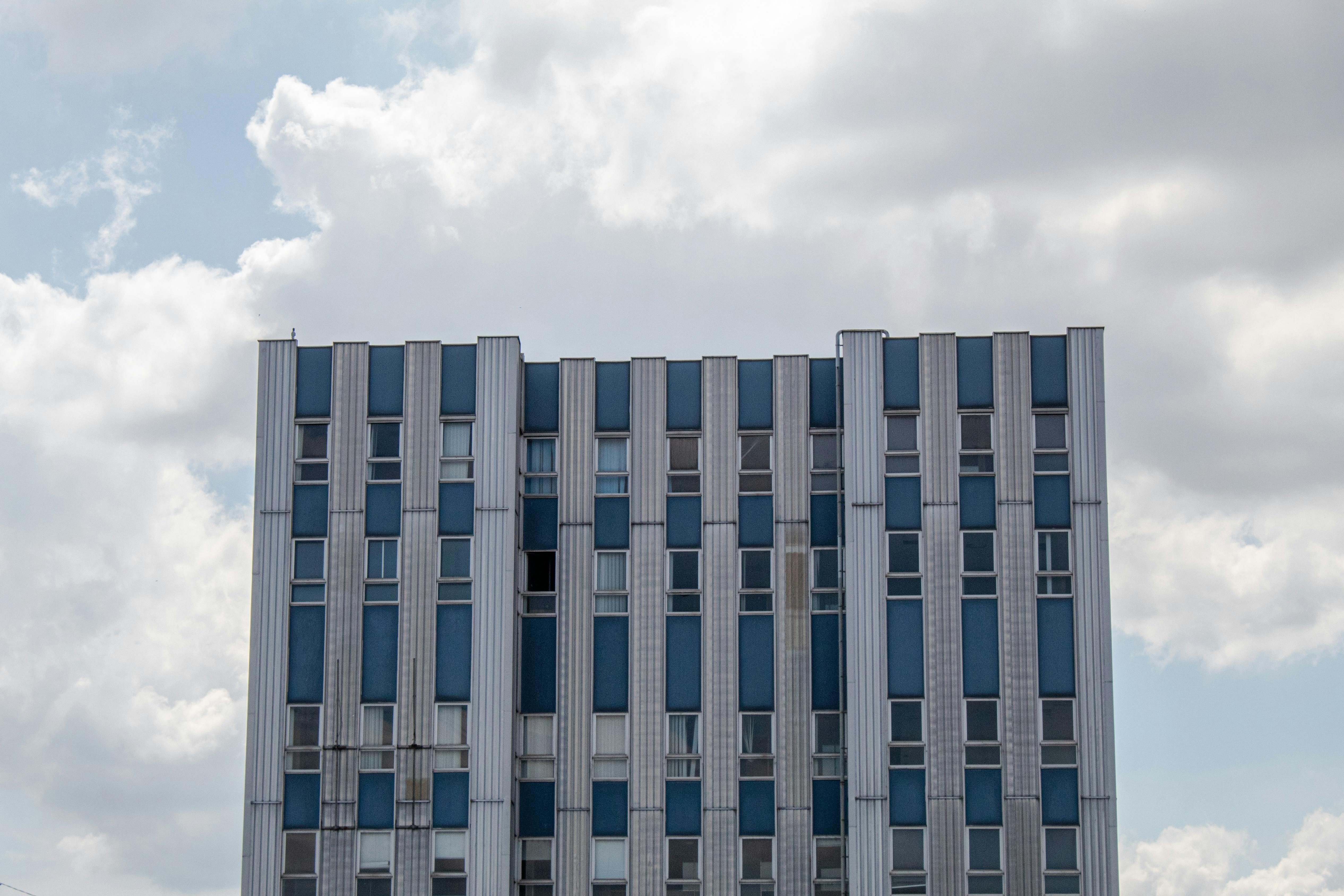 White and Blue Concrete Building Under White Clouds · Free Stock Photo