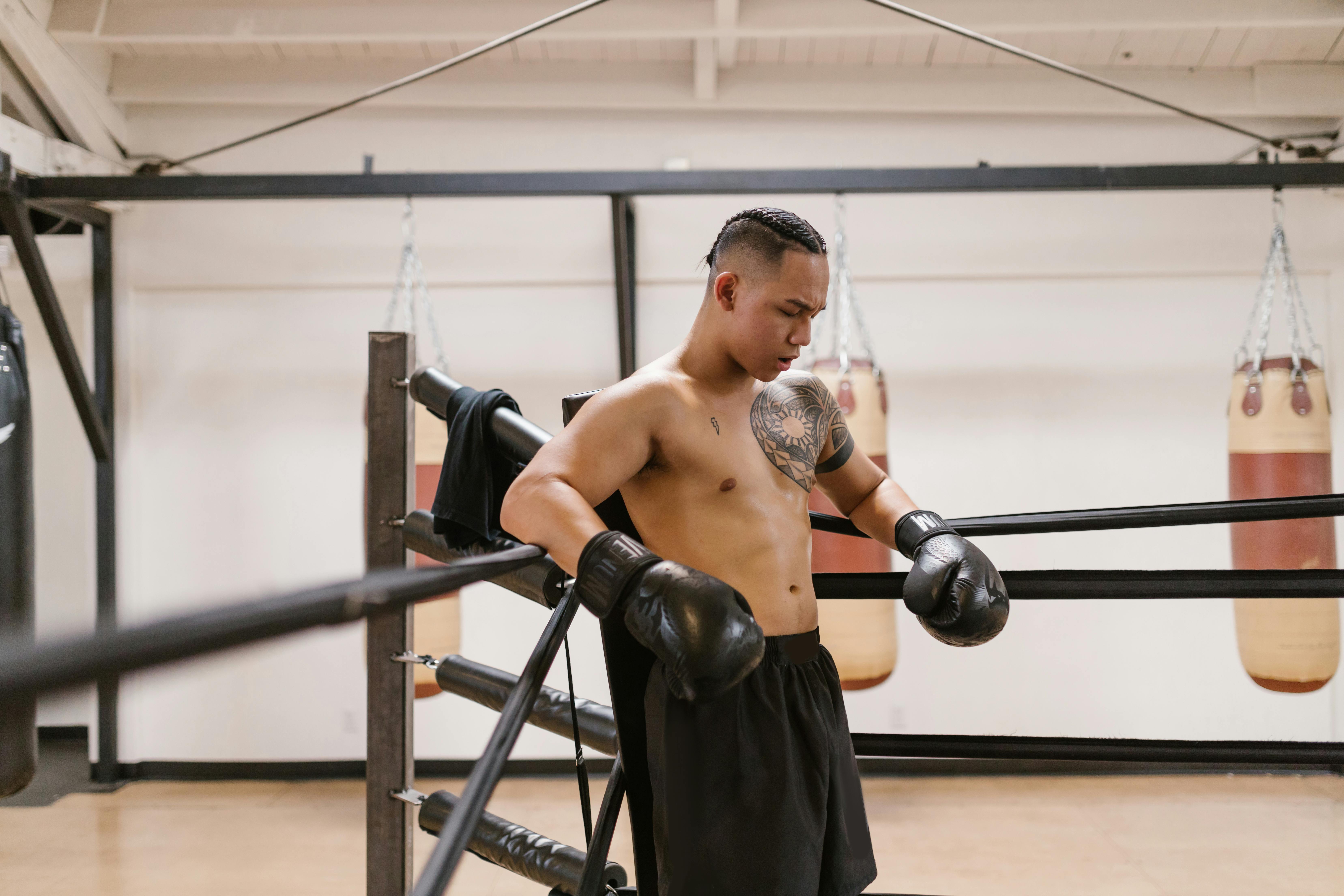 Woman Sparring with a Man in a Boxing Ring · Free Stock Photo