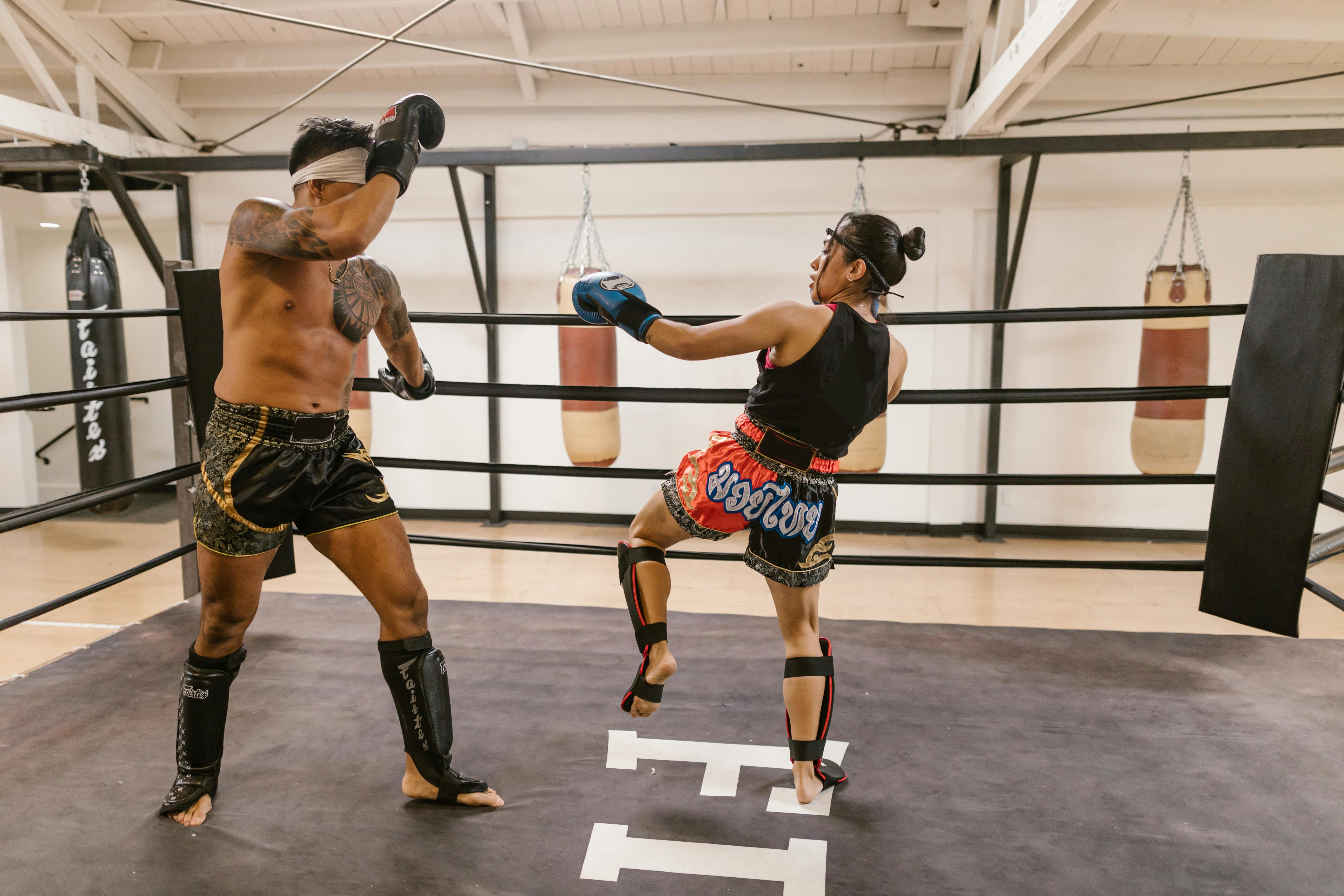 Woman and Man Kickboxing · Free Stock Photo