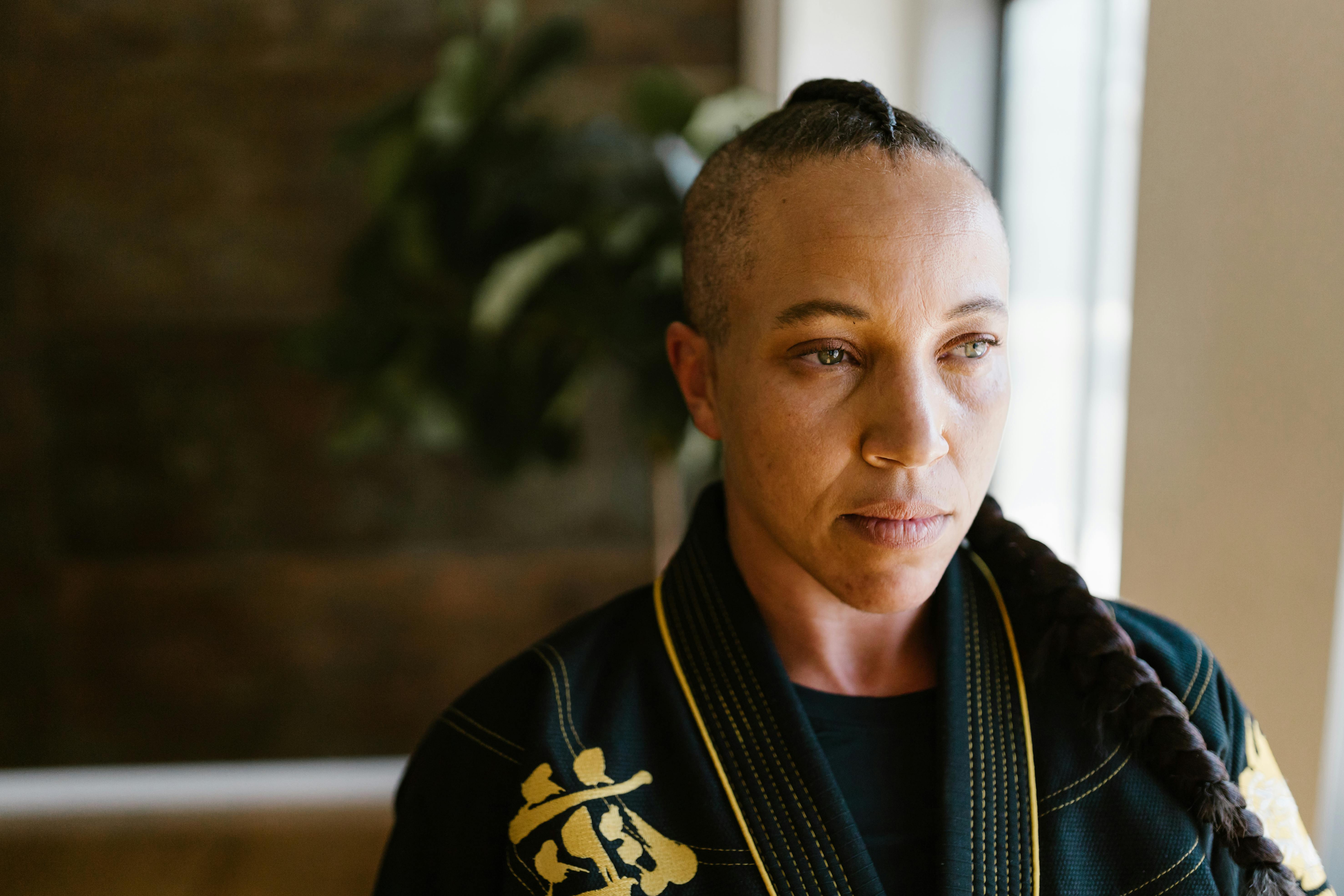 A Woman with Braided Hair Wearing a Pink Gi · Free Stock Photo