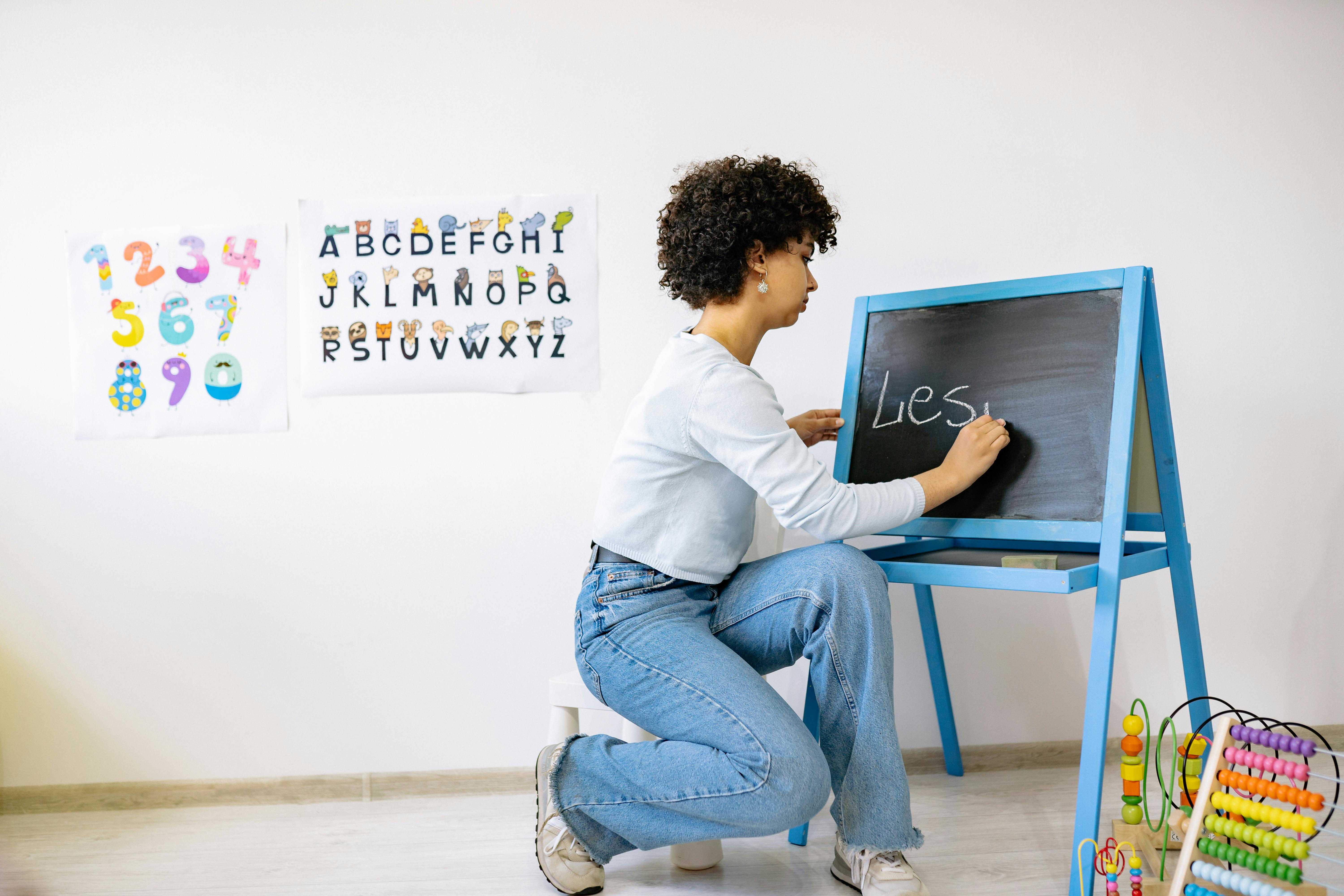 A Woman Writing on a Blackboard · Free Stock Photo