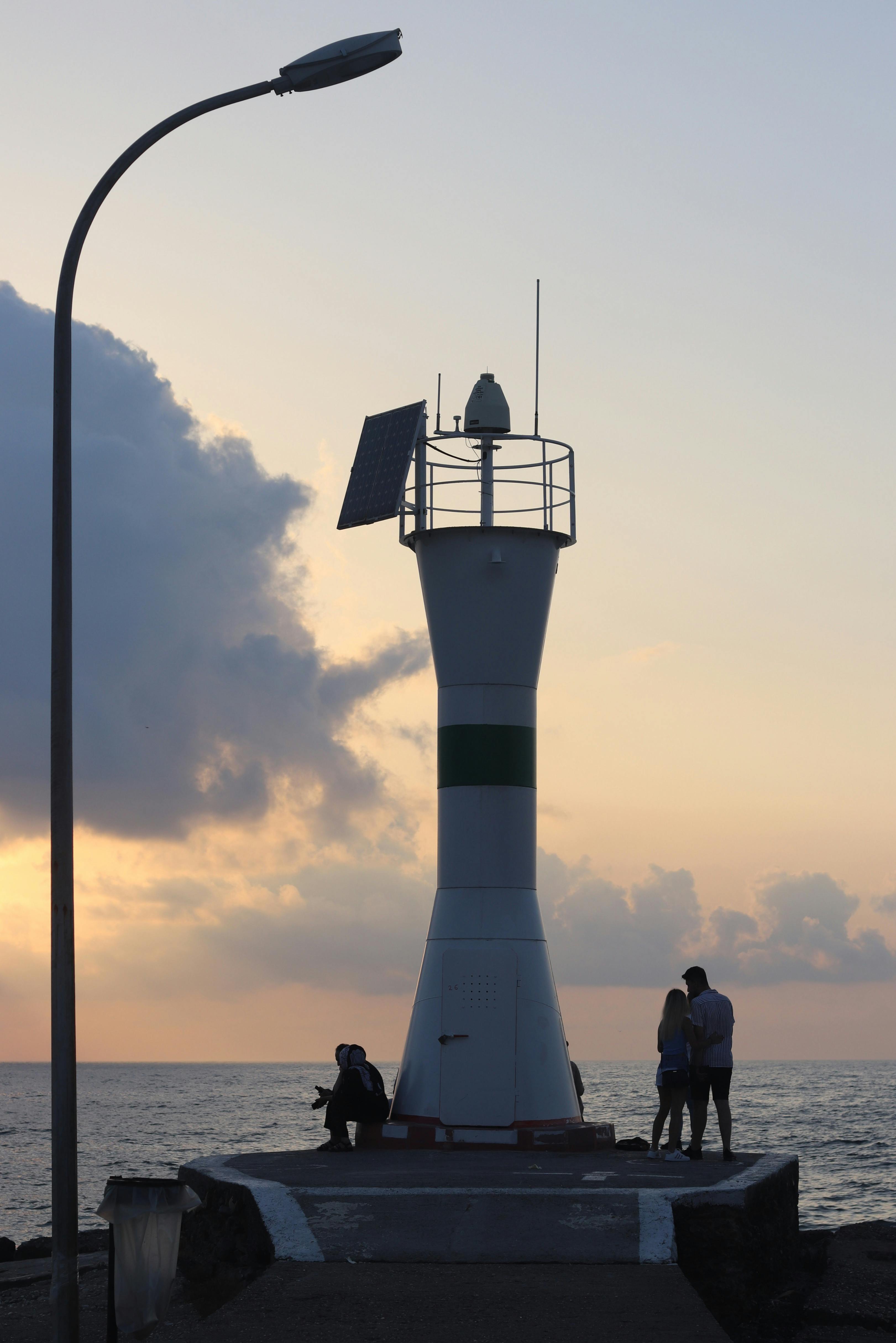 Lighthouse and People Standing Around It Looking at the Seascape · Free ...