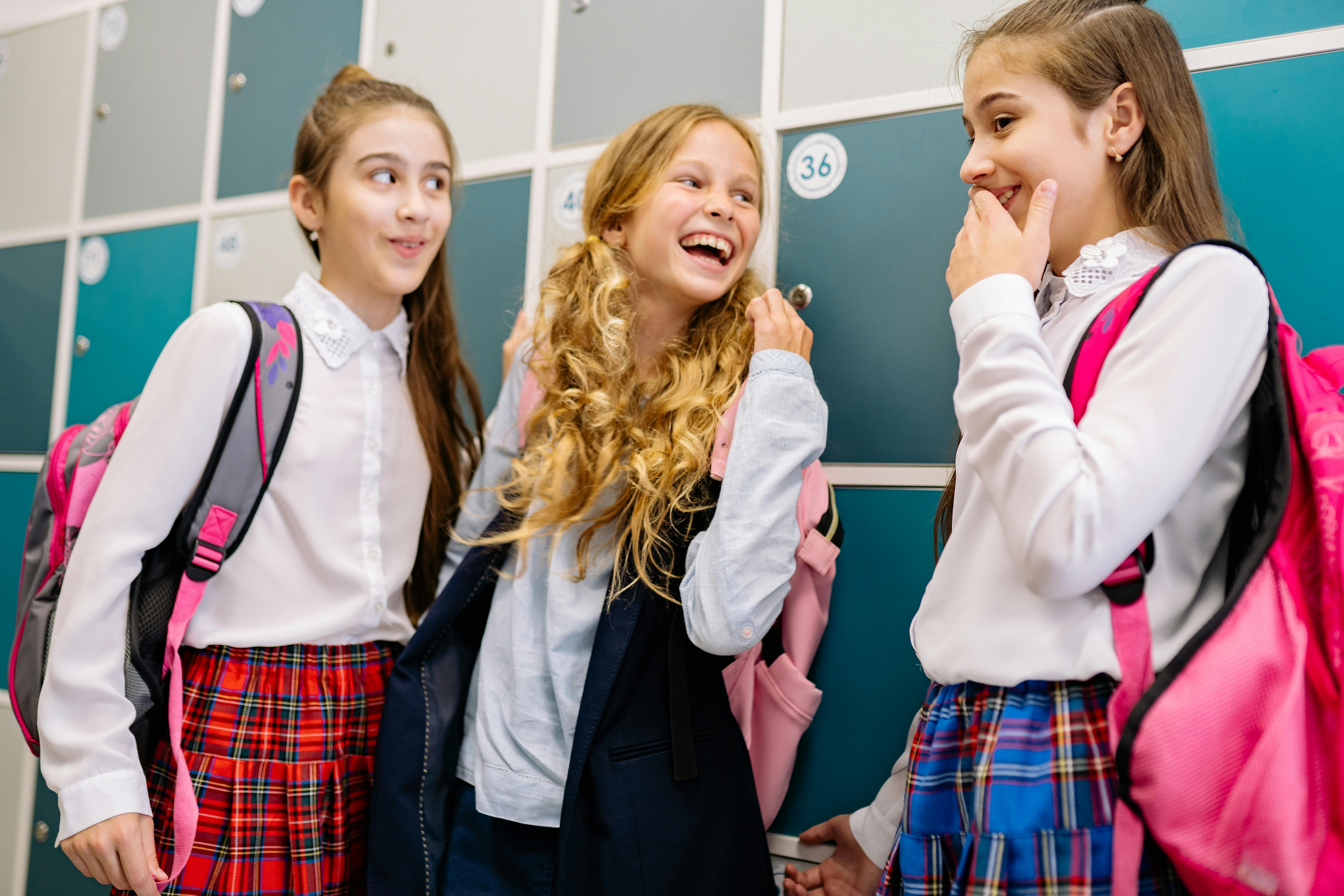 Three Girls Talking Together in the School · Free Stock Photo