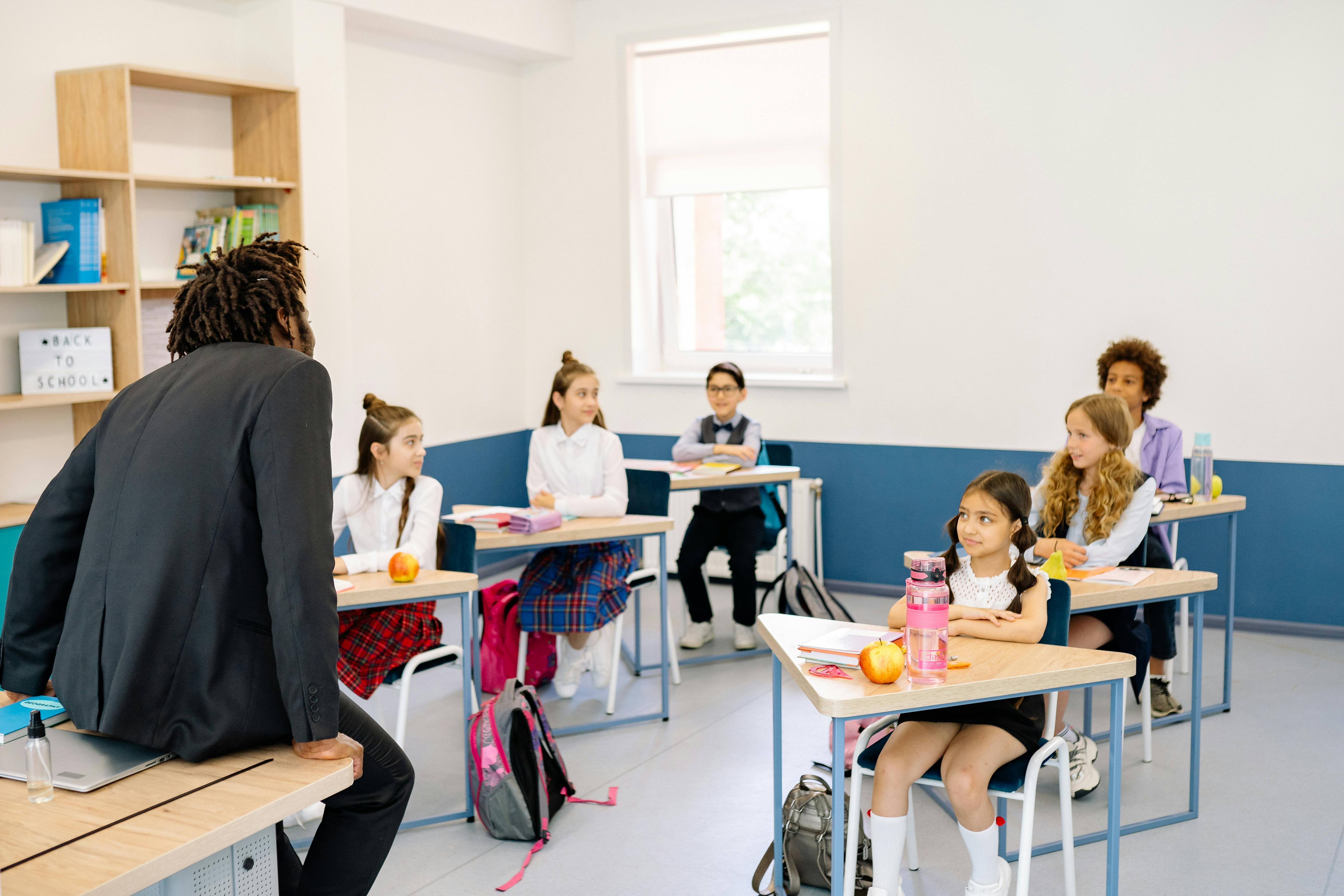 Boy Sitting among Colleagues · Free Stock Photo