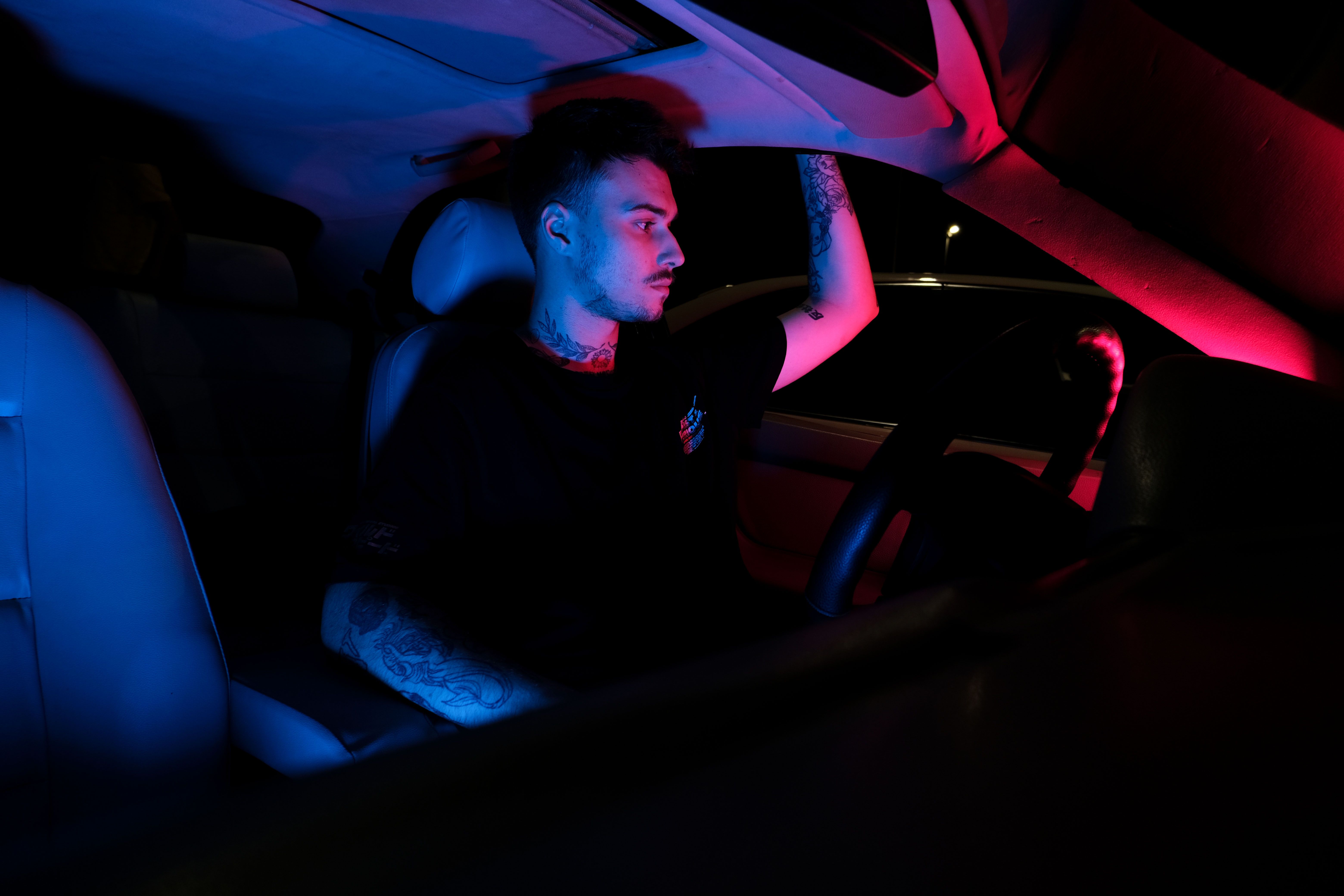 Man Sitting At the Back Holding a Camera · Free Stock Photo
