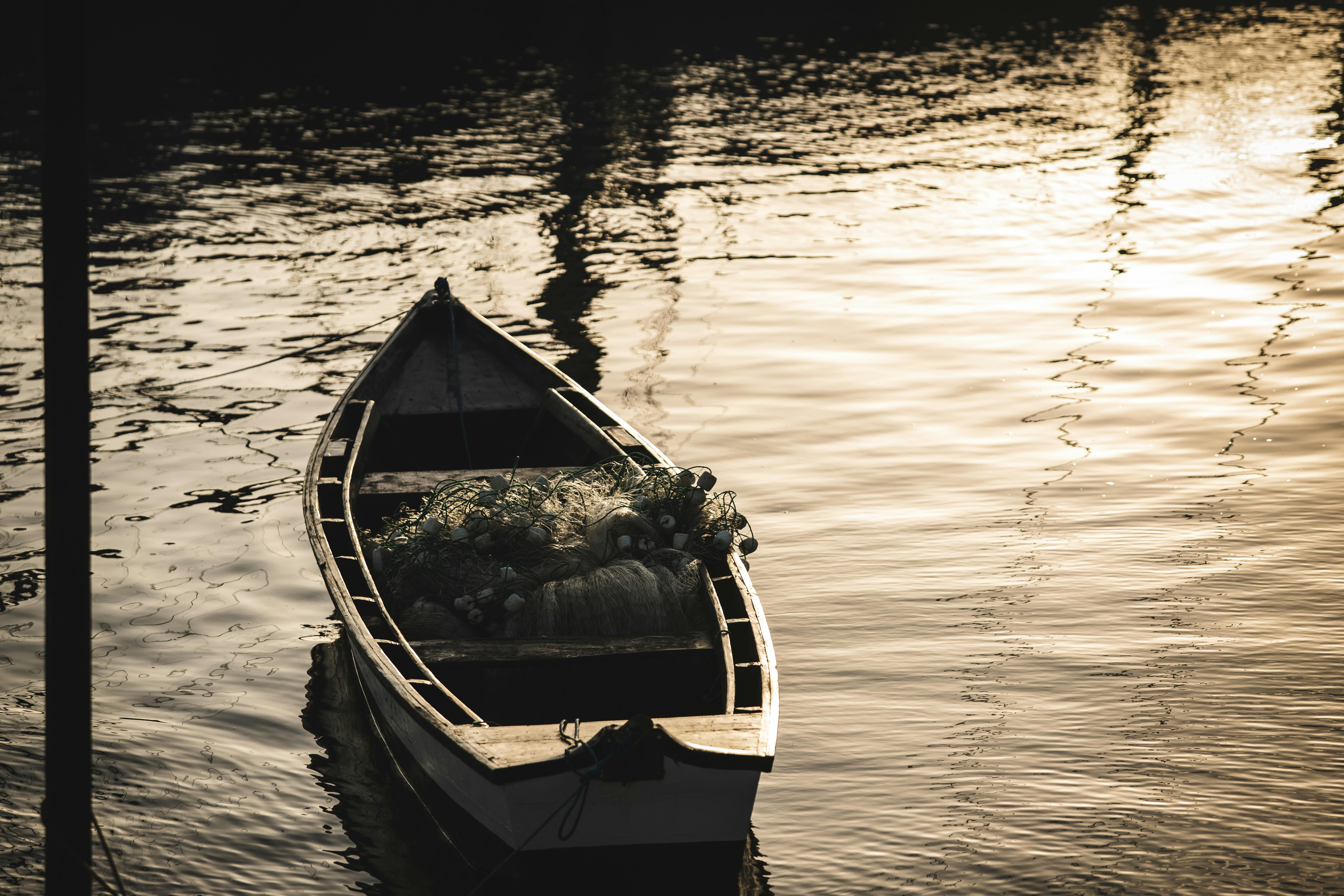 Two Person Riding Boat on Body of Water · Free Stock Photo