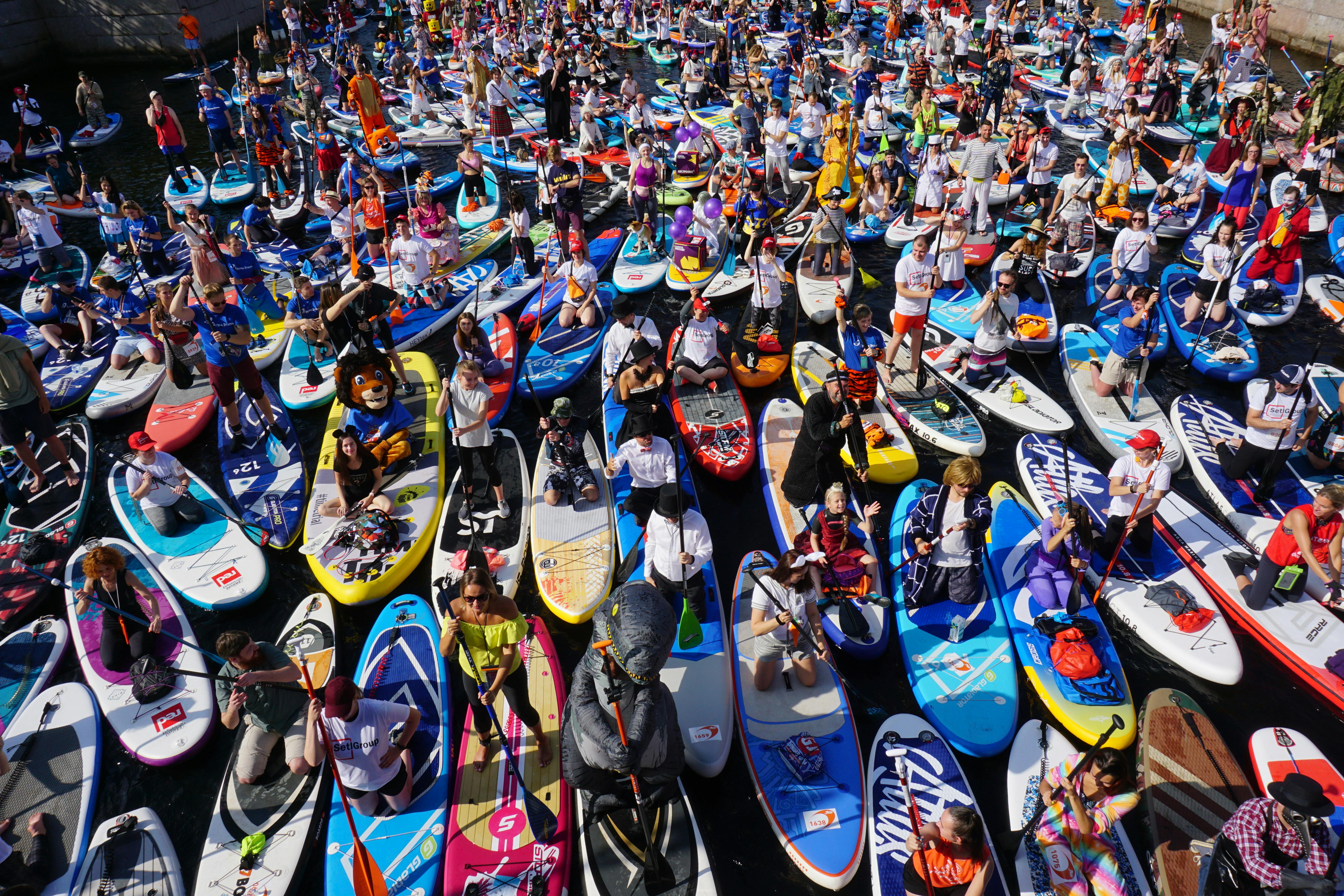 People Standing on Floating Paddleboards · Free Stock Photo