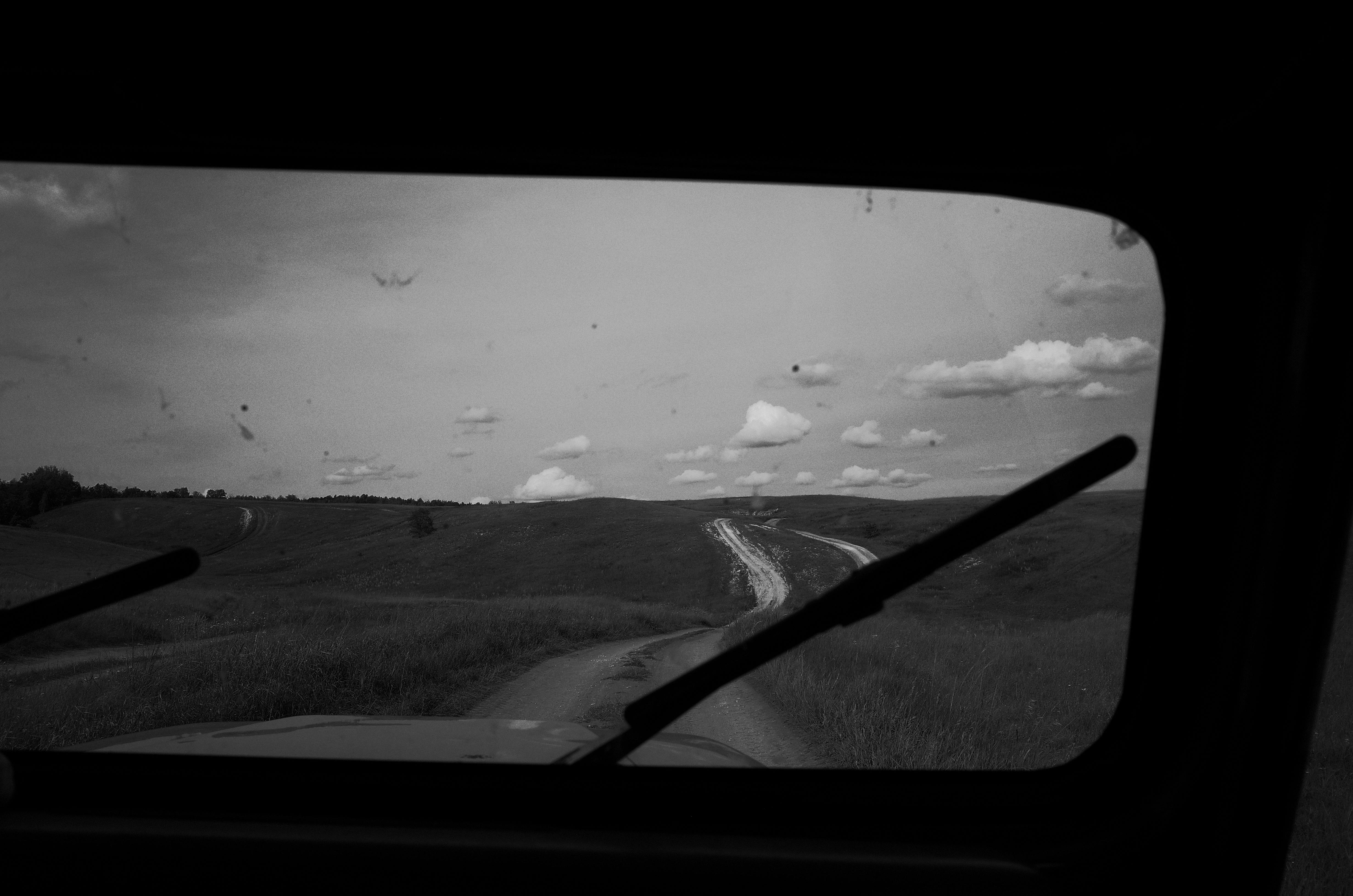 Grayscale Photo of a Car on the Countryside · Free Stock Photo