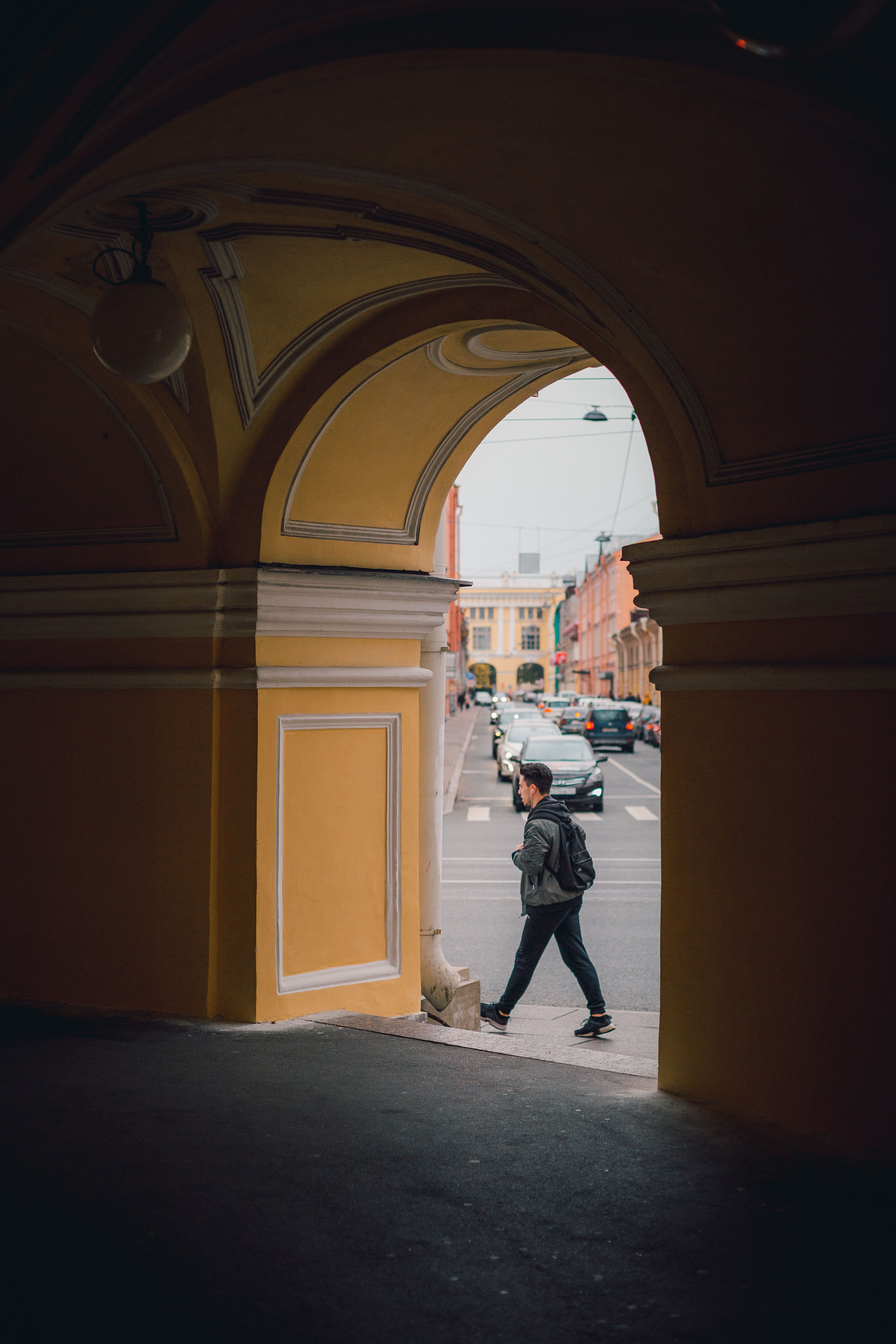 A Man Passing Outside an Arched Passage · Free Stock Photo