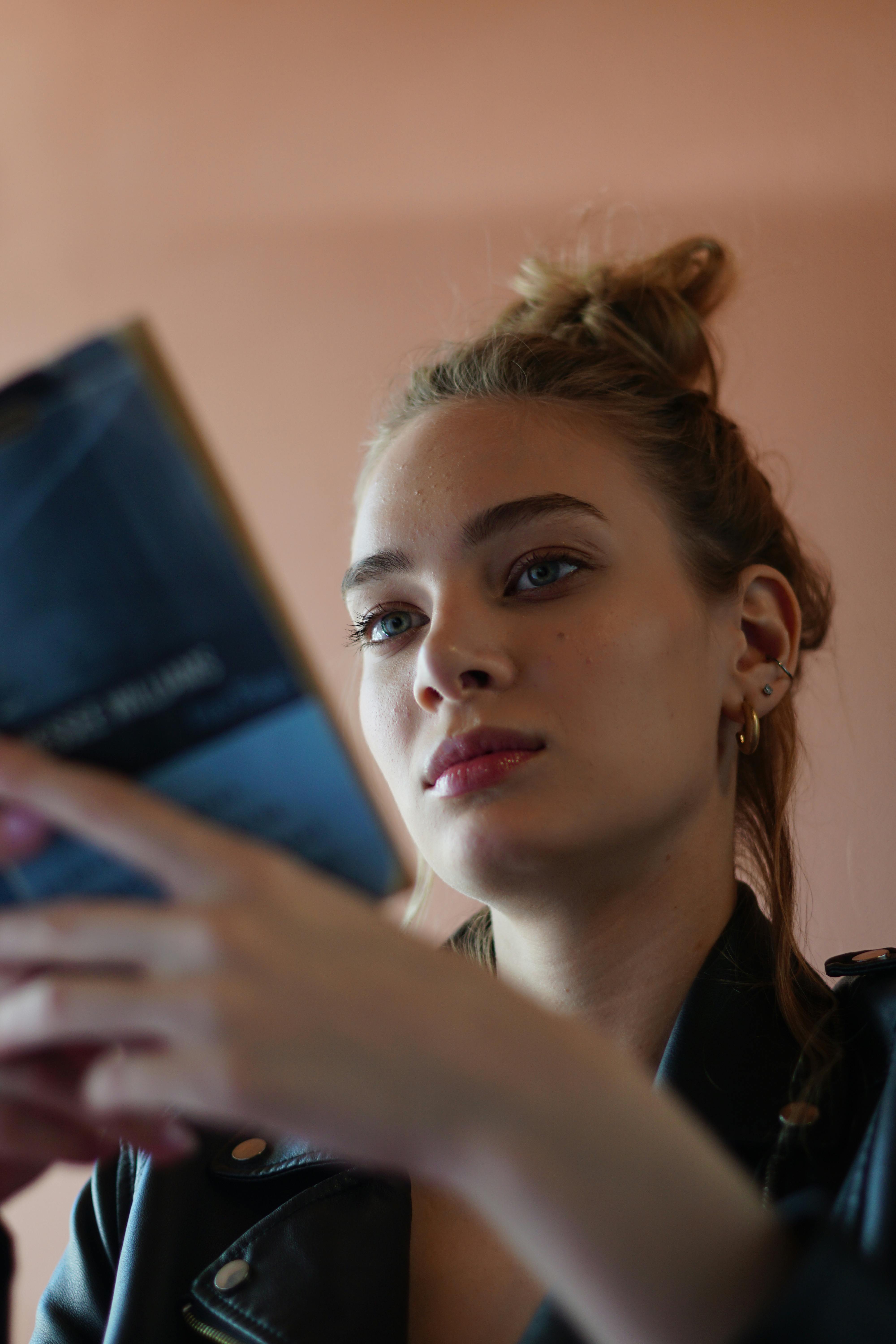 Woman with Blue Eyes Reading Book · Free Stock Photo
