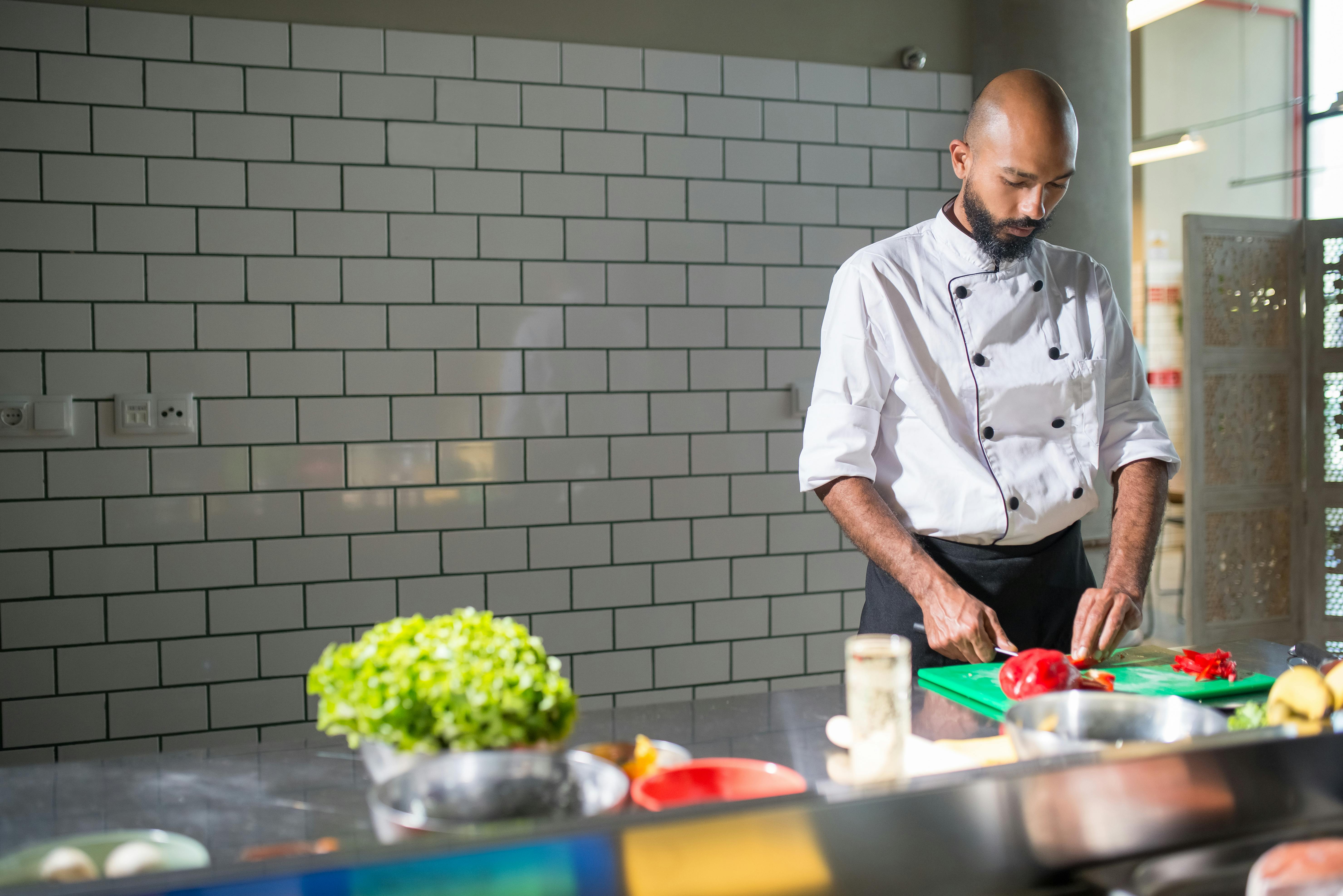 A Chef Slicing Peppers · Free Stock Photo