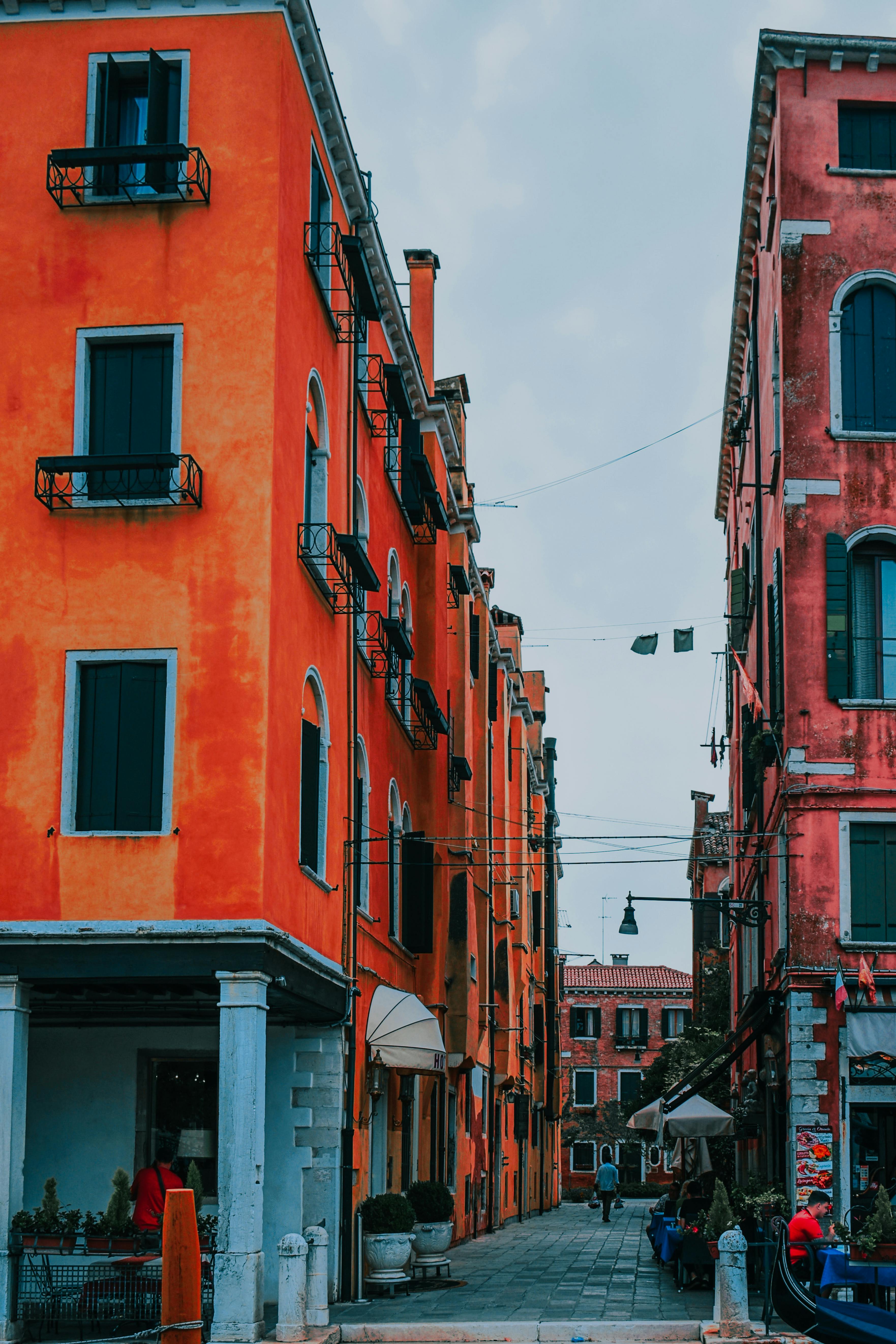 Red and Orange Concrete Buildings Under the White Sky · Free Stock Photo