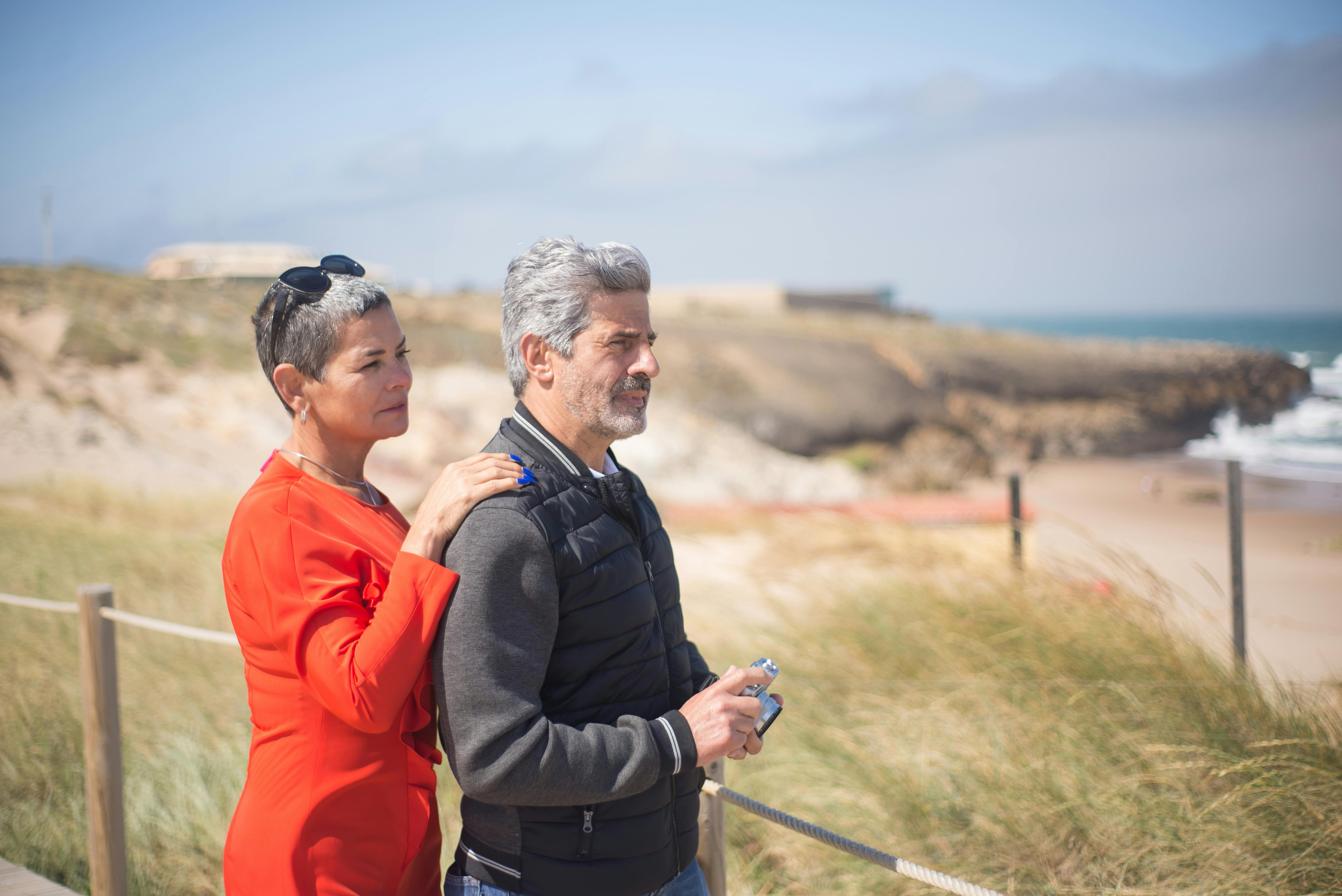 A Woman Touching Man's Back while Looking Afar · Free Stock Photo