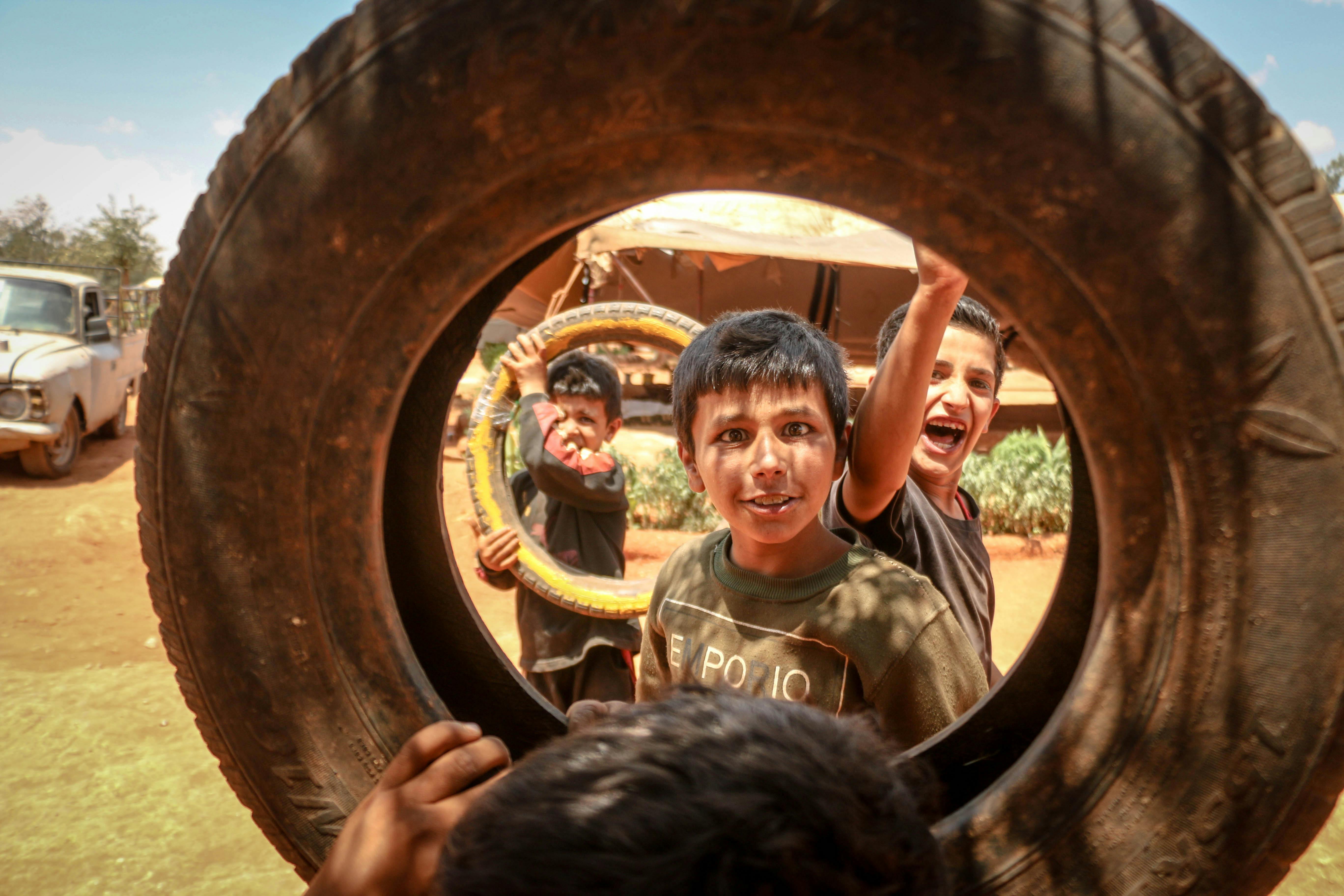 Boys Playing with Tires · Free Stock Photo