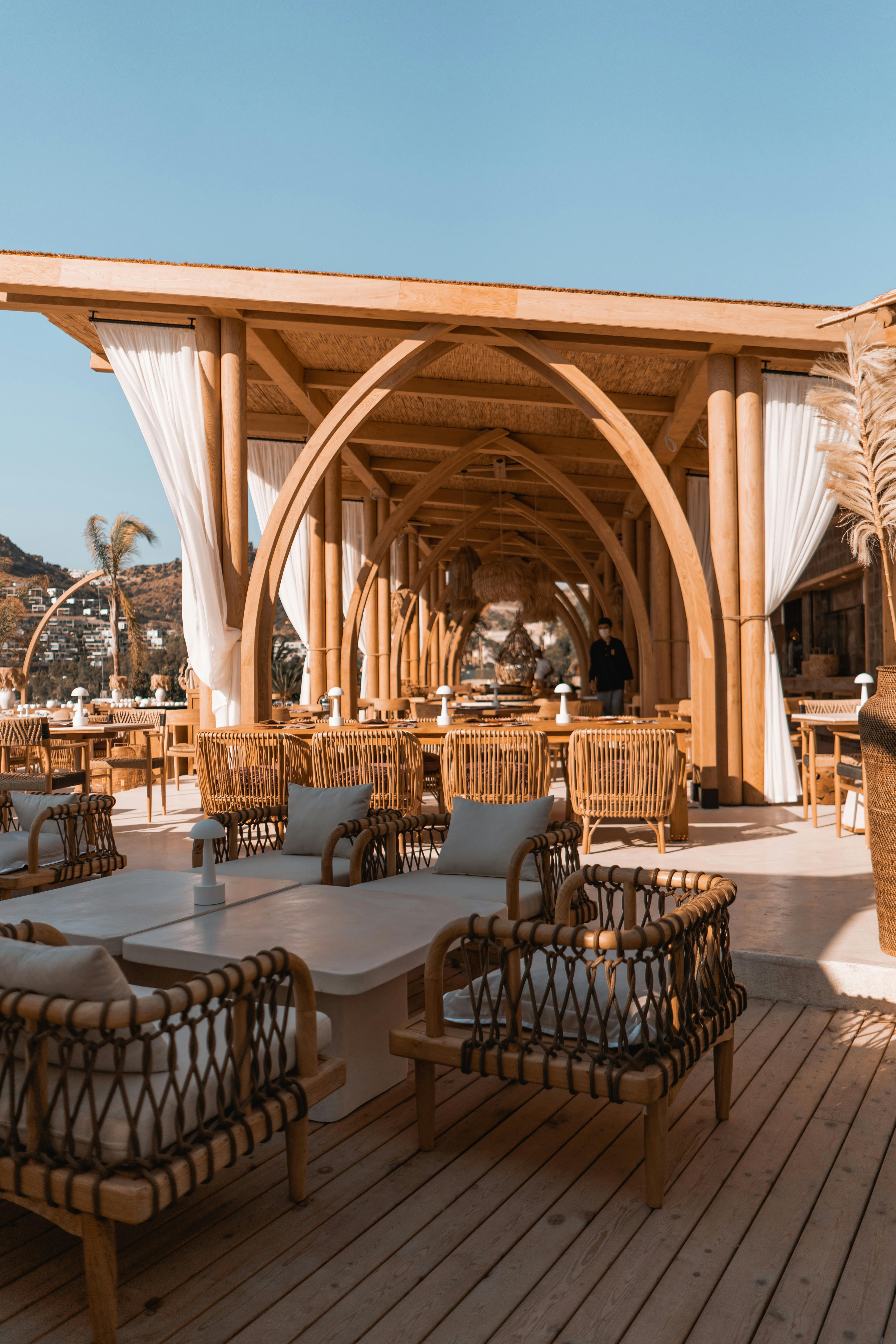 Tables and Chairs in an Open Door Restaurant · Free Stock Photo