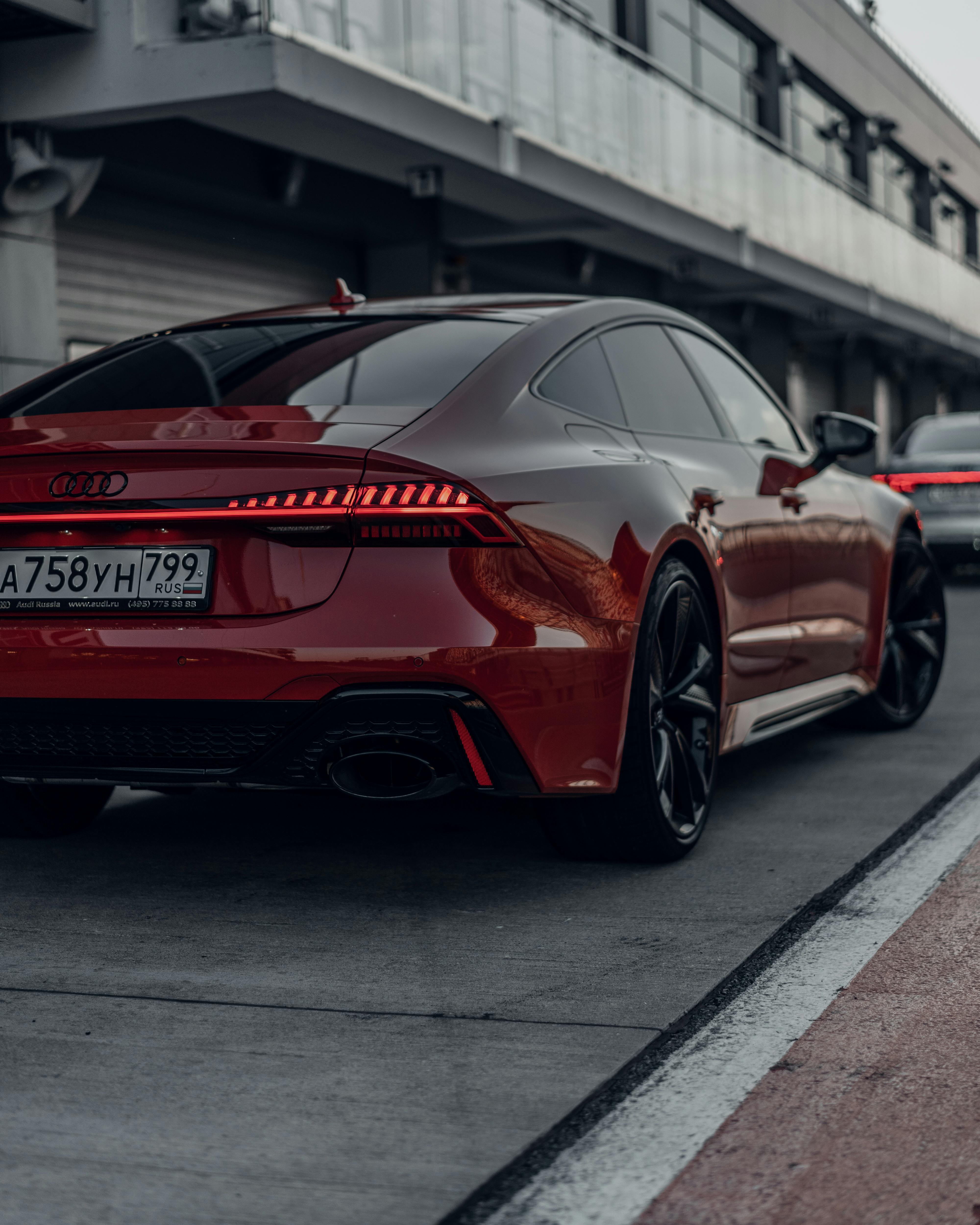 Red Sedan On Grey Concrete Road · Free Stock Photo