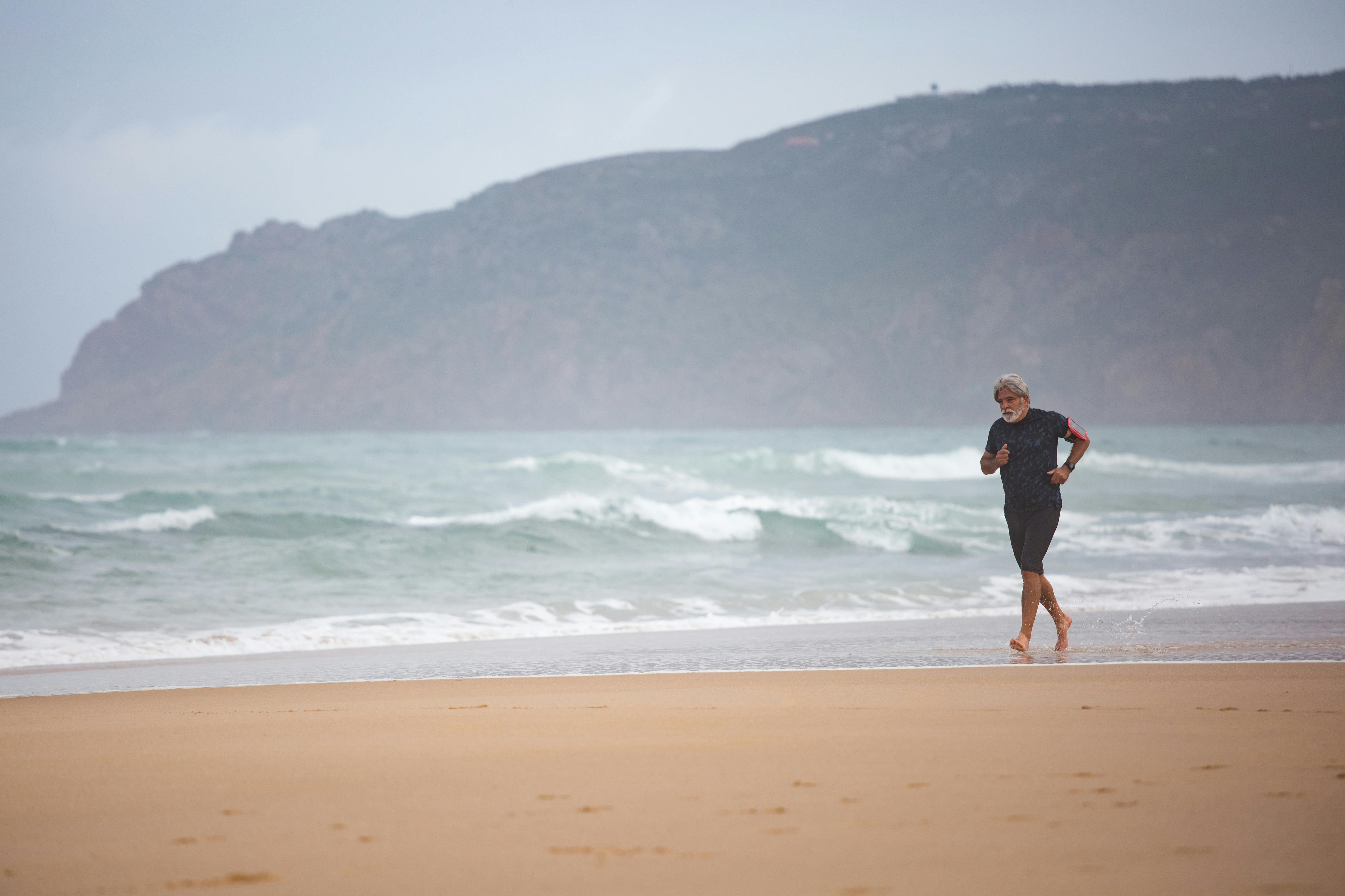 A Man Running Near the Shore · Free Stock Photo