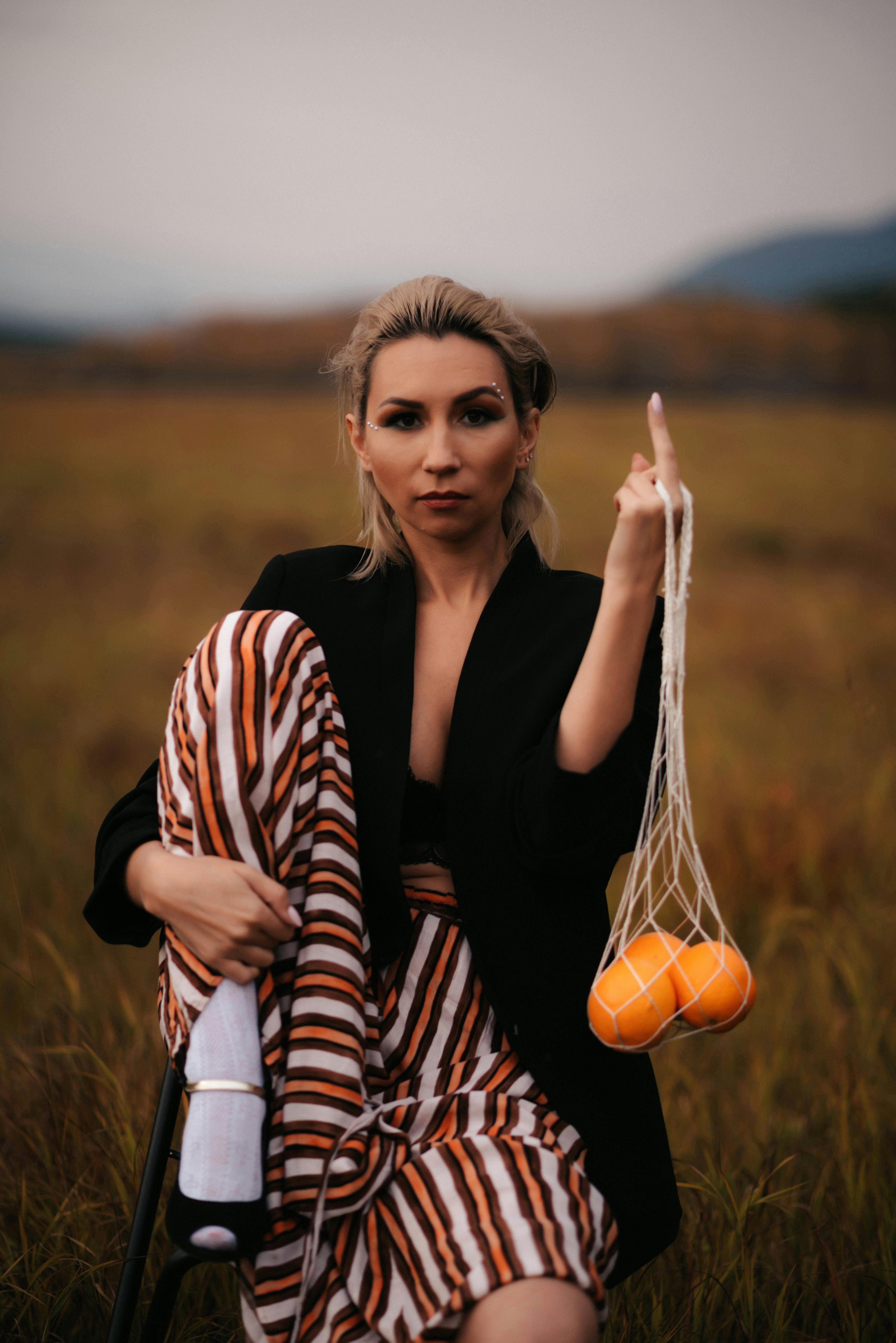 A Woman in an Olive Jacket Showing her Middle Finger · Free Stock Photo