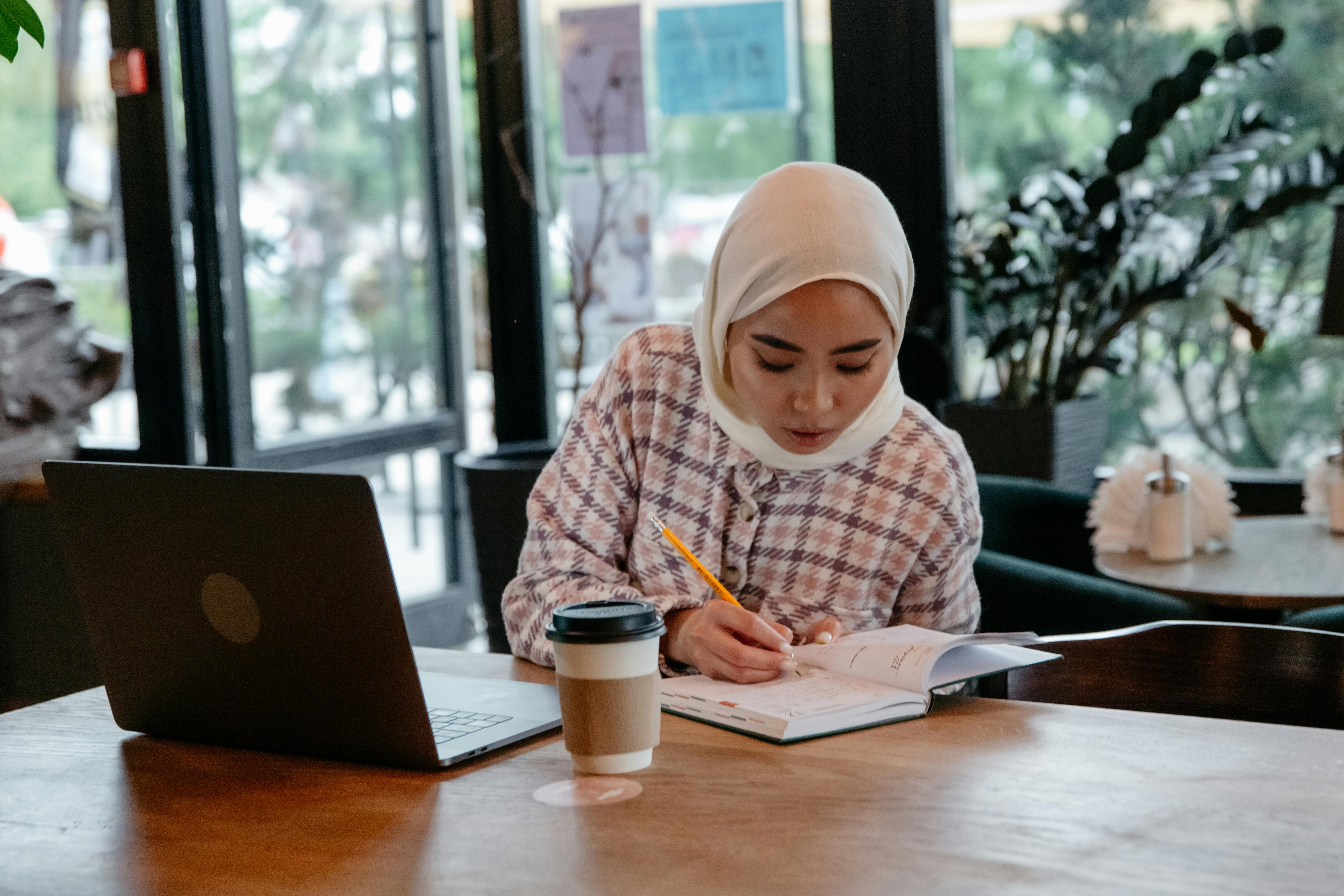 A Woman Writing at the Table · Free Stock Photo