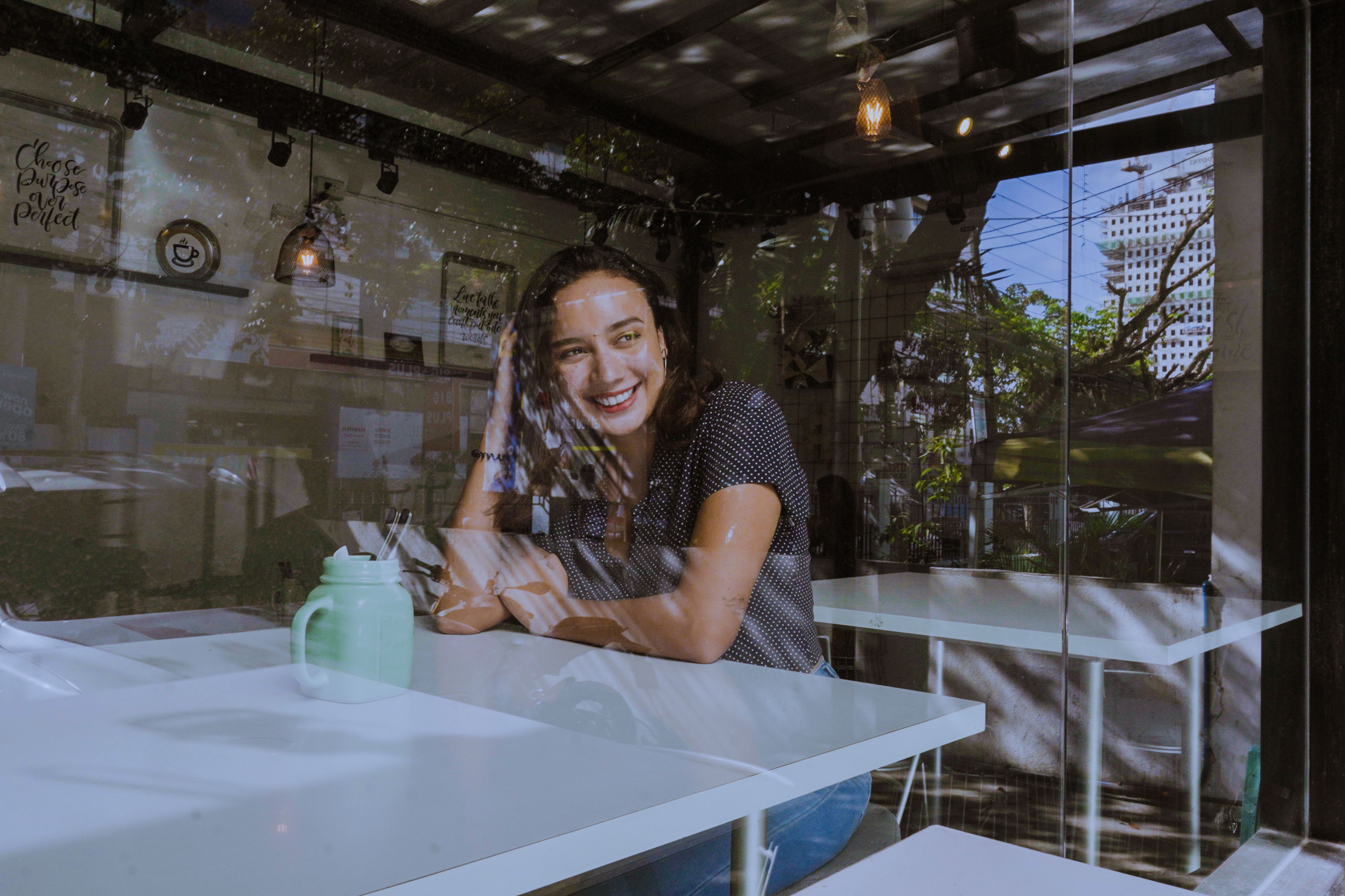 Smiling Woman behind Window · Free Stock Photo