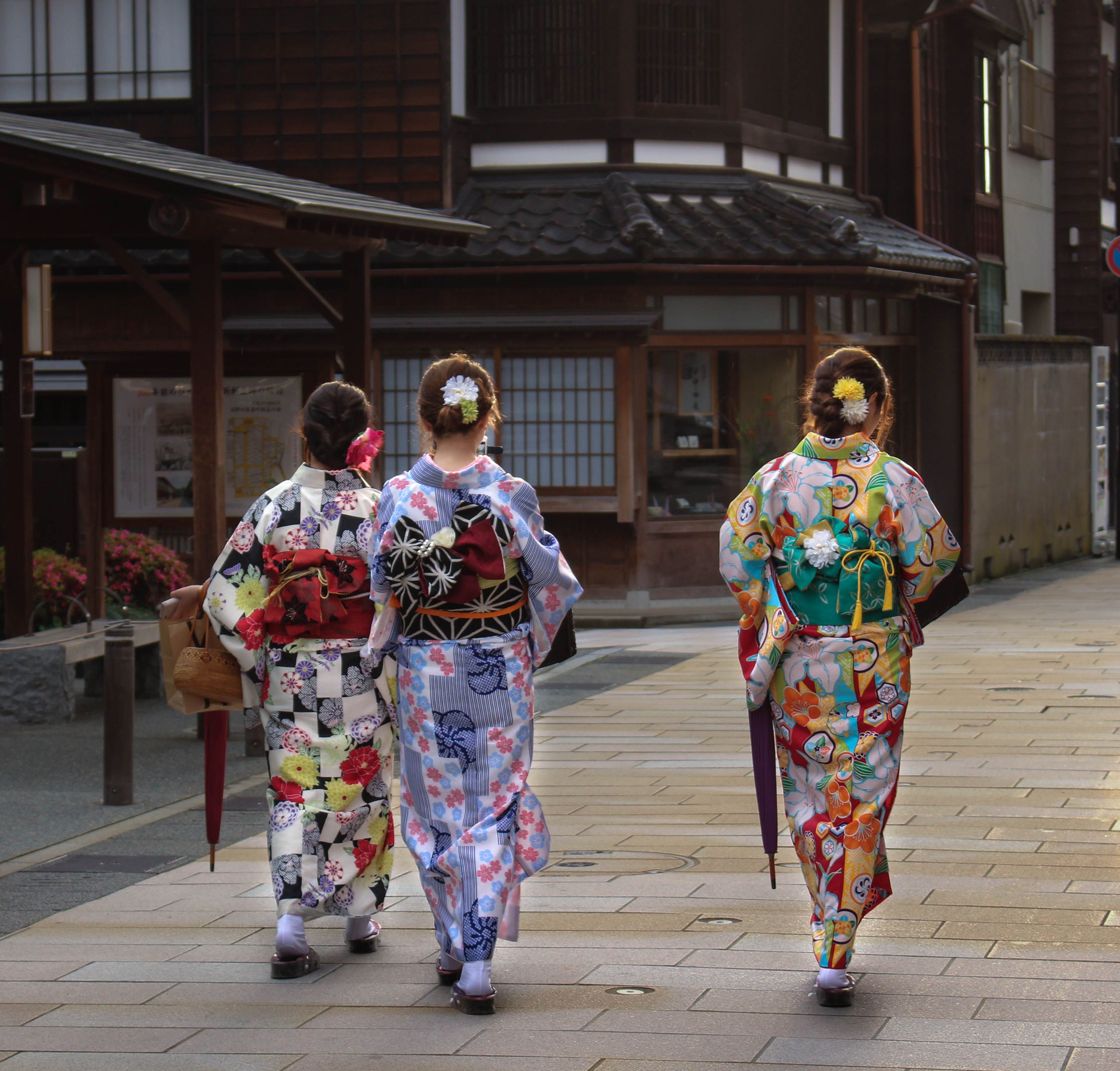 Three Geisha Walking Between Buildings · Free Stock Photo
