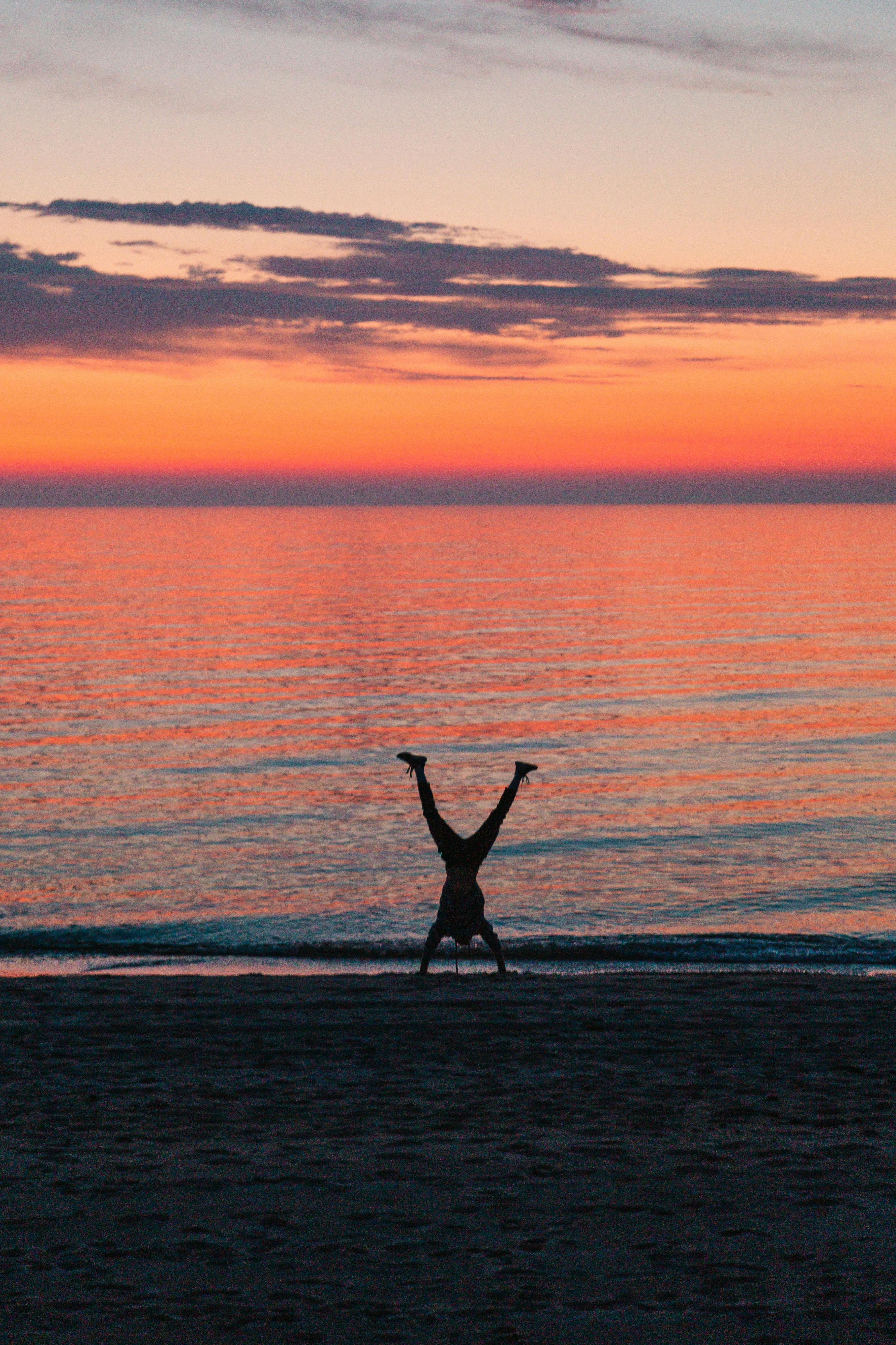 A Silhouette of a Person Doing a Handstand · Free Stock Photo