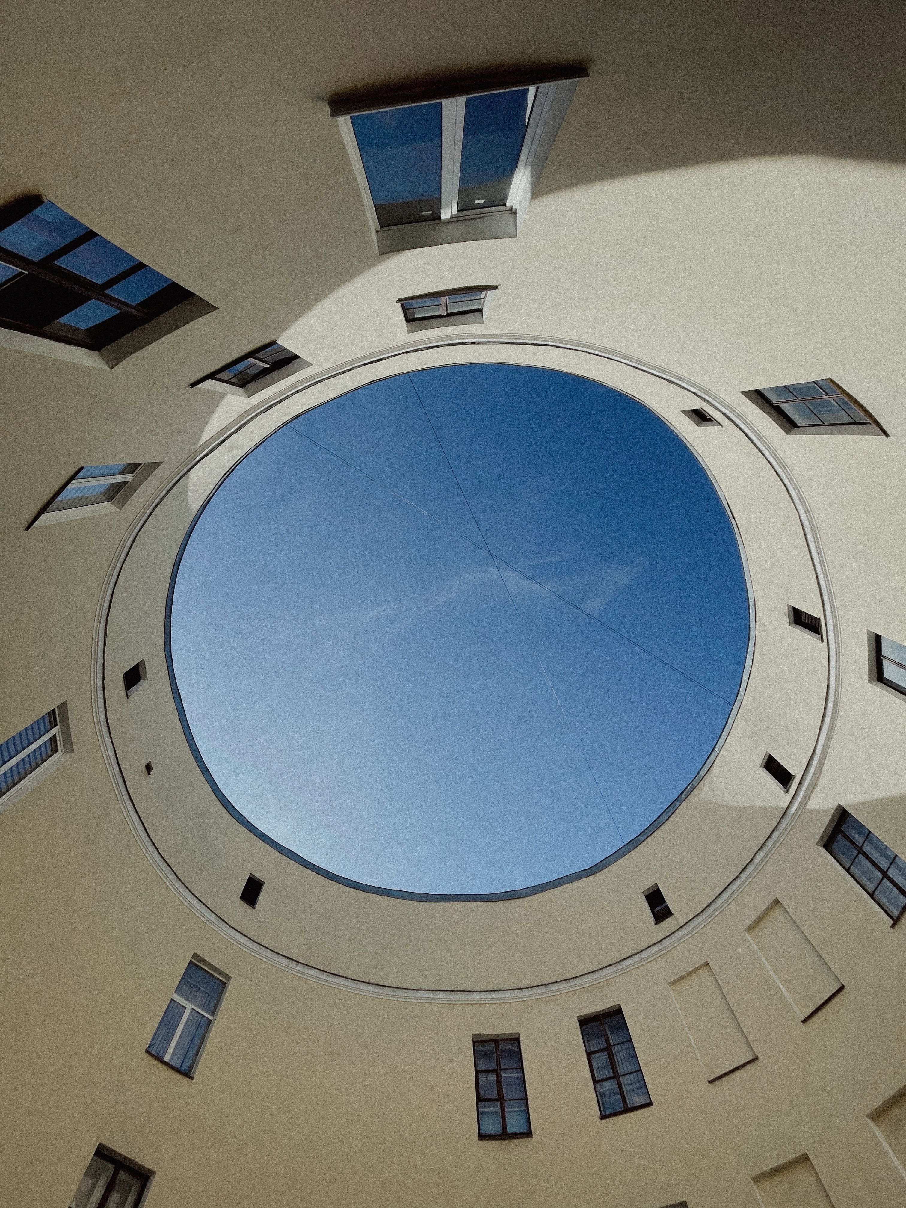 Upward View of Sky from Patio of Round Building · Free Stock Photo