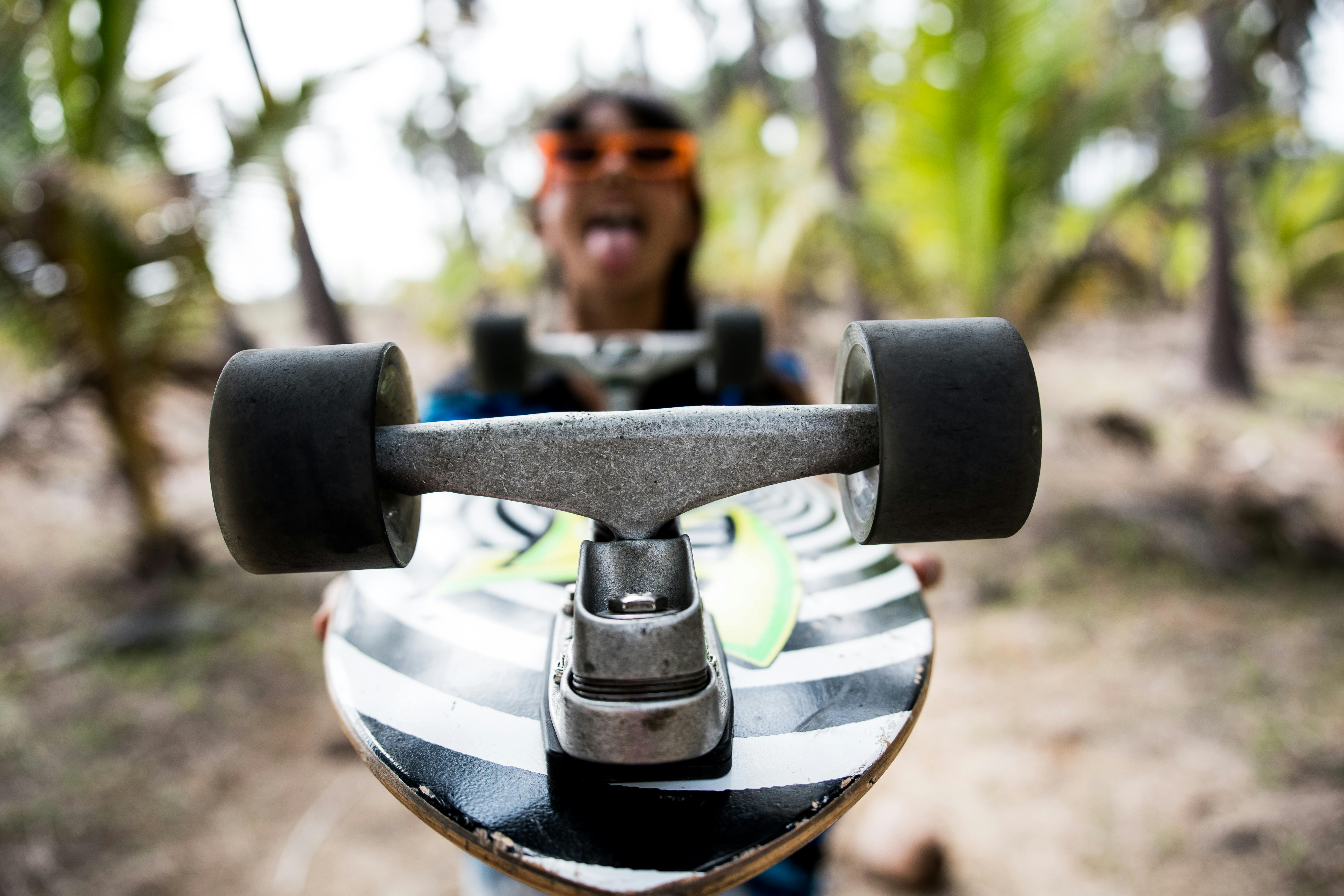 Person in White Sneakers Riding Longboard · Free Stock Photo