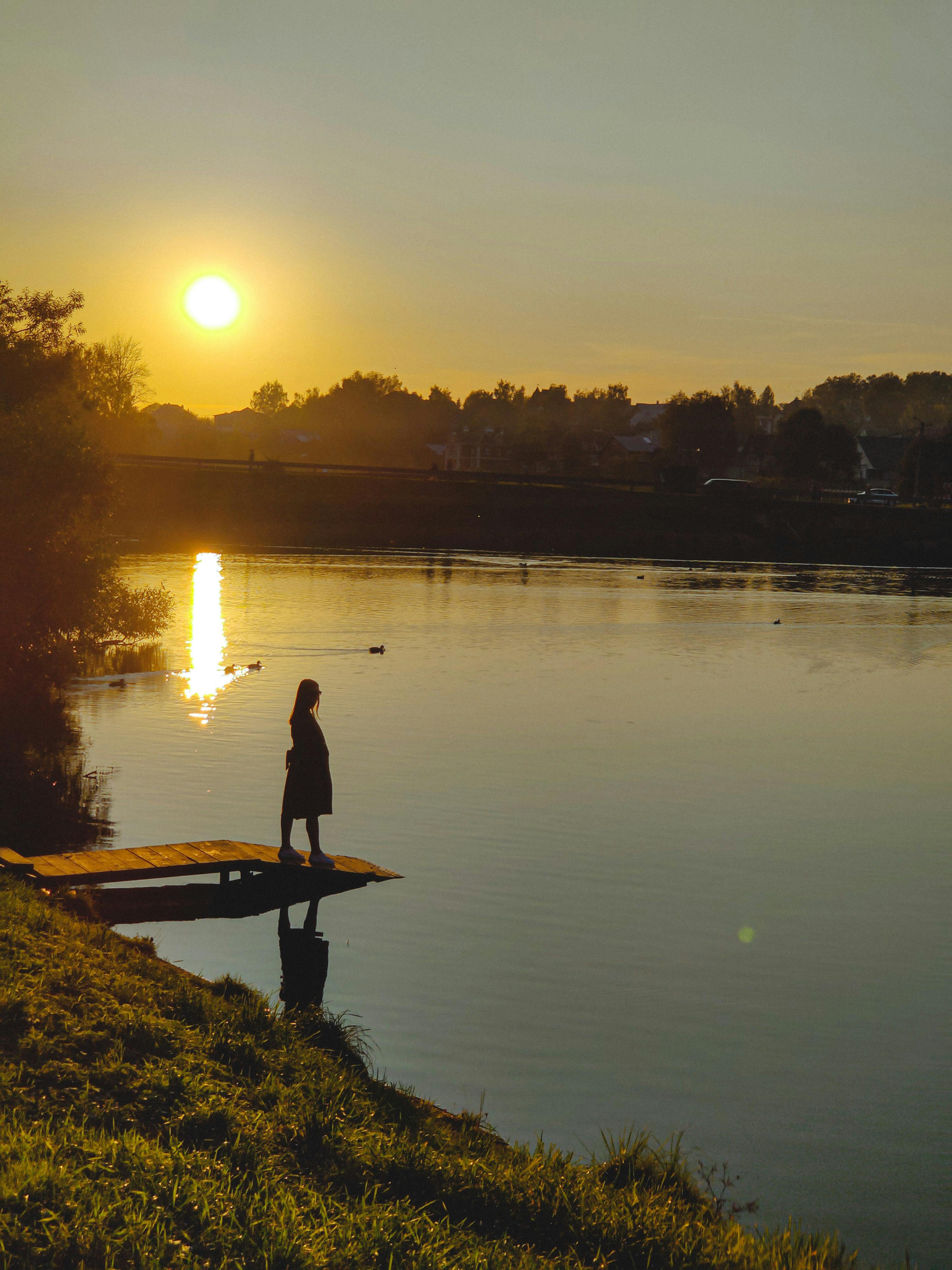 People Sitting on Brown Wooden Dock · Free Stock Photo