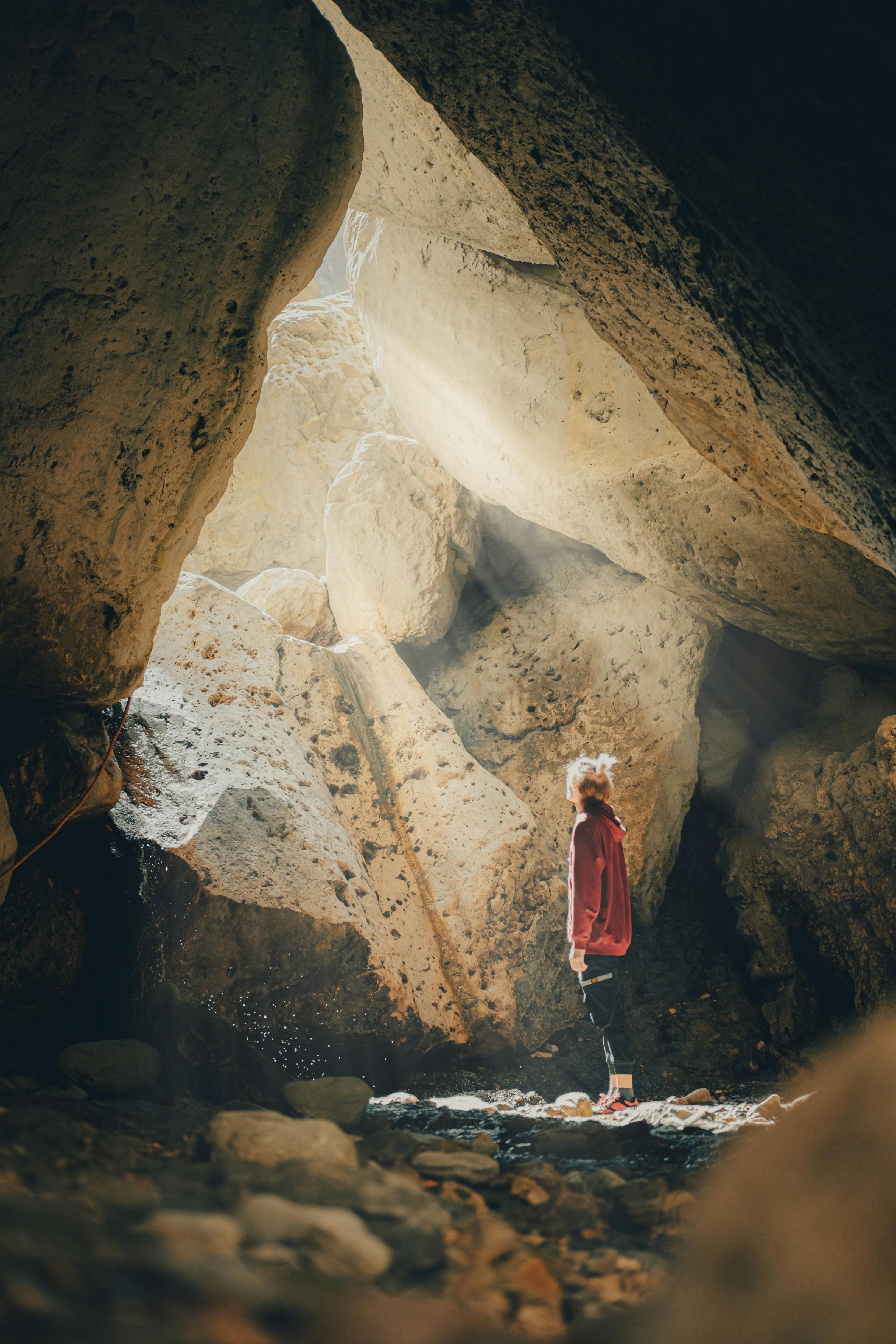 A Person Standing inside the Cave · Free Stock Photo