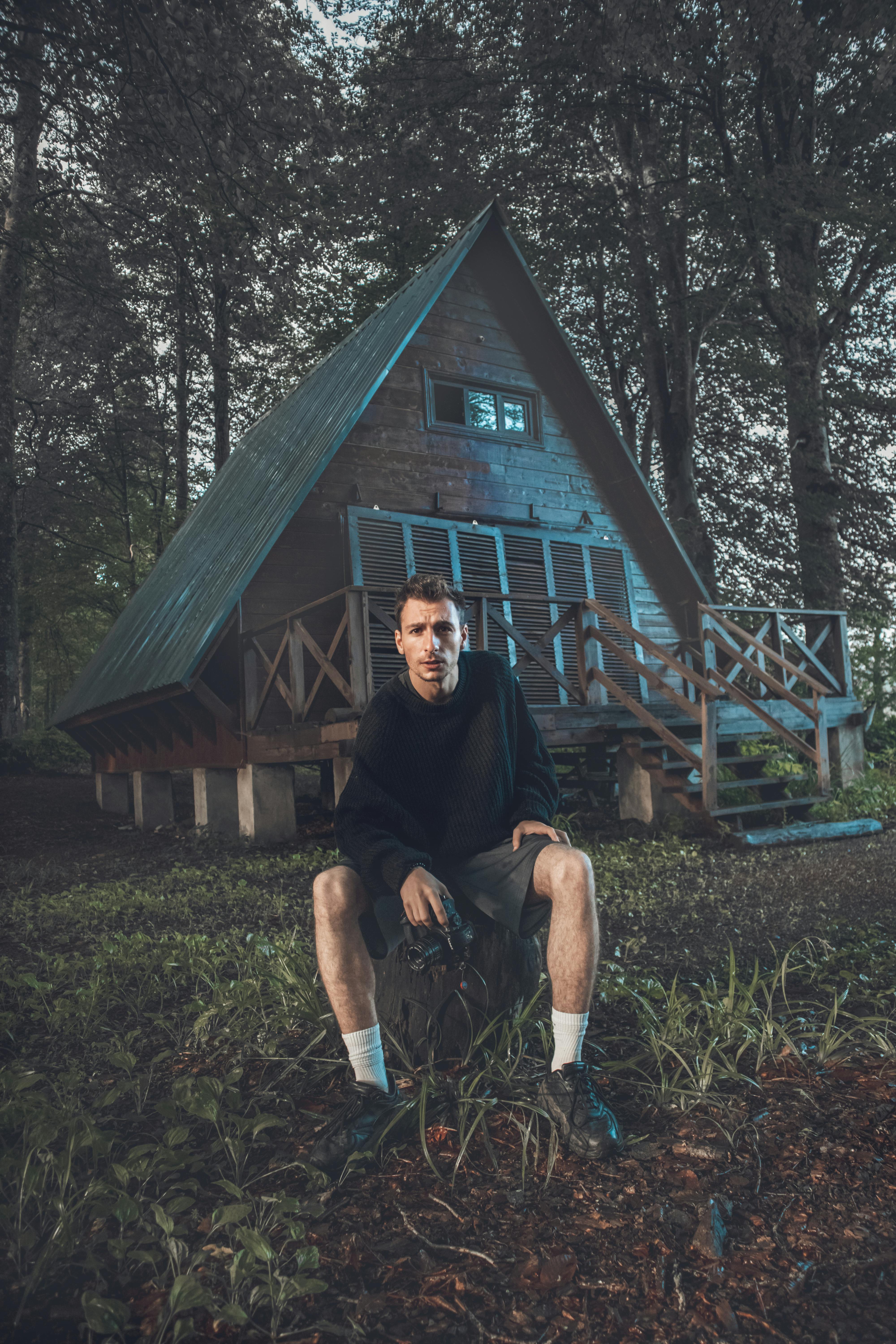 A Man Sitting on a Tree Stump · Free Stock Photo