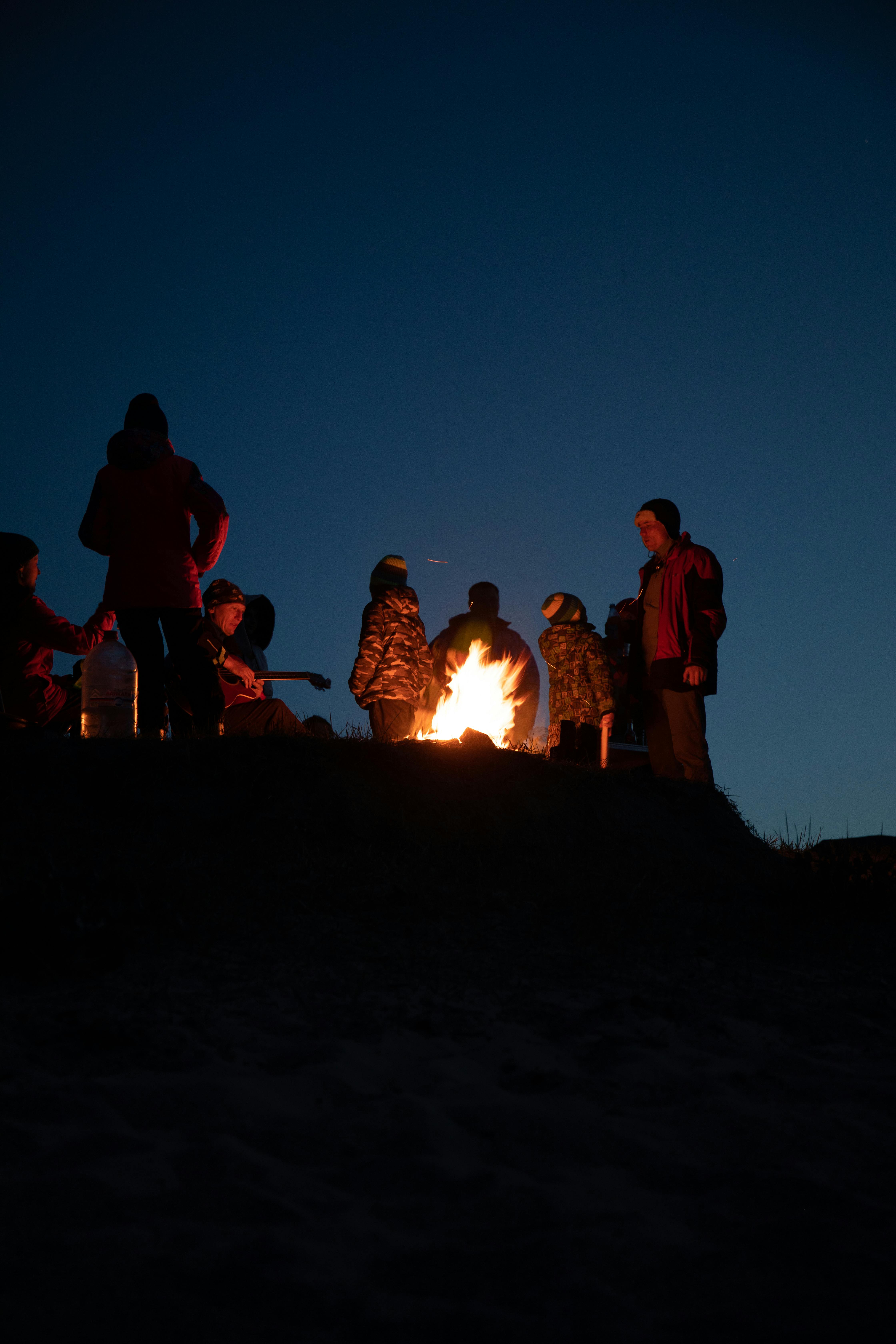 Group of People Standing on a Bonfire · Free Stock Photo
