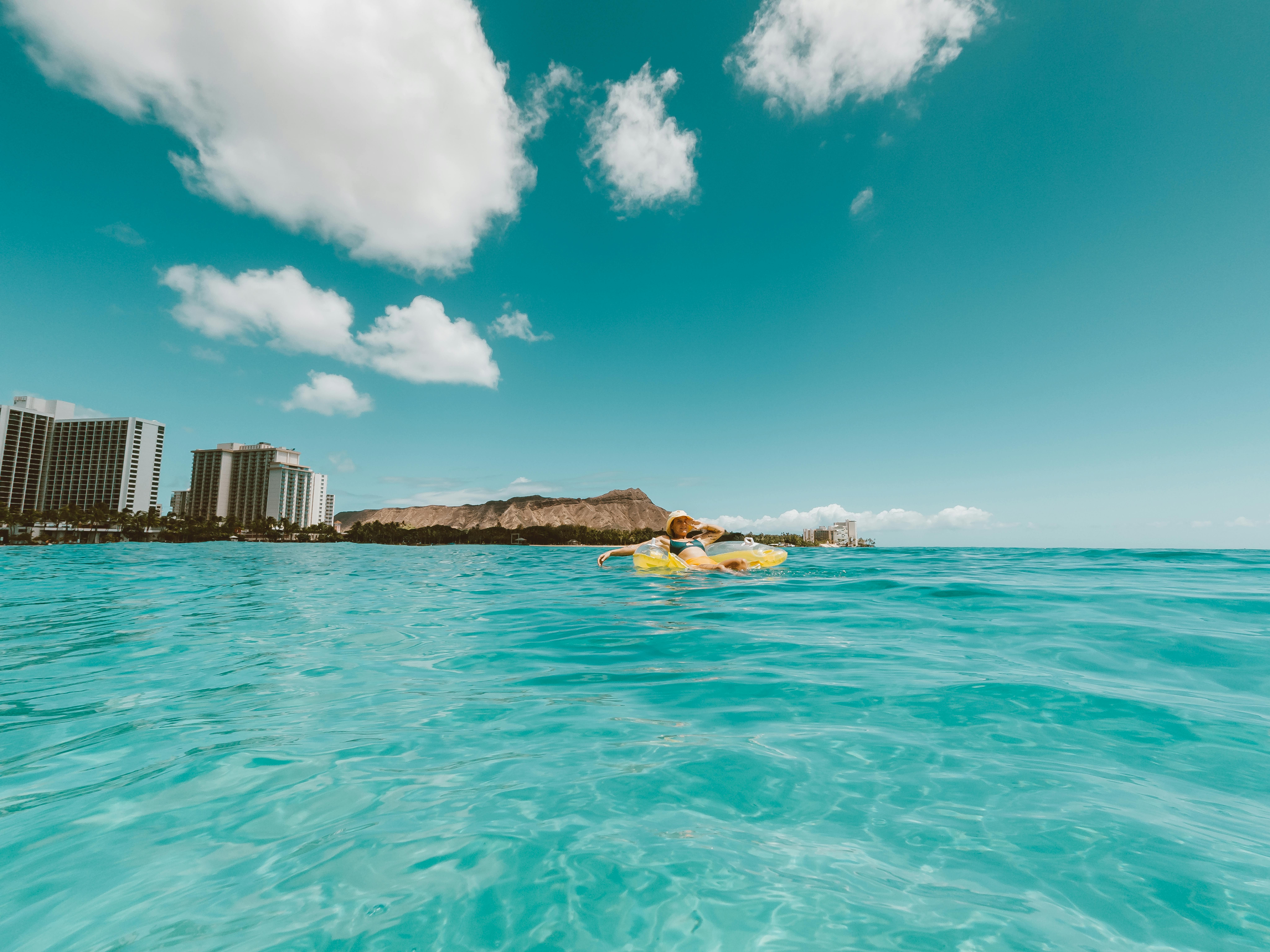 Photo of a Woman Using a Floater on the Sea · Free Stock Photo