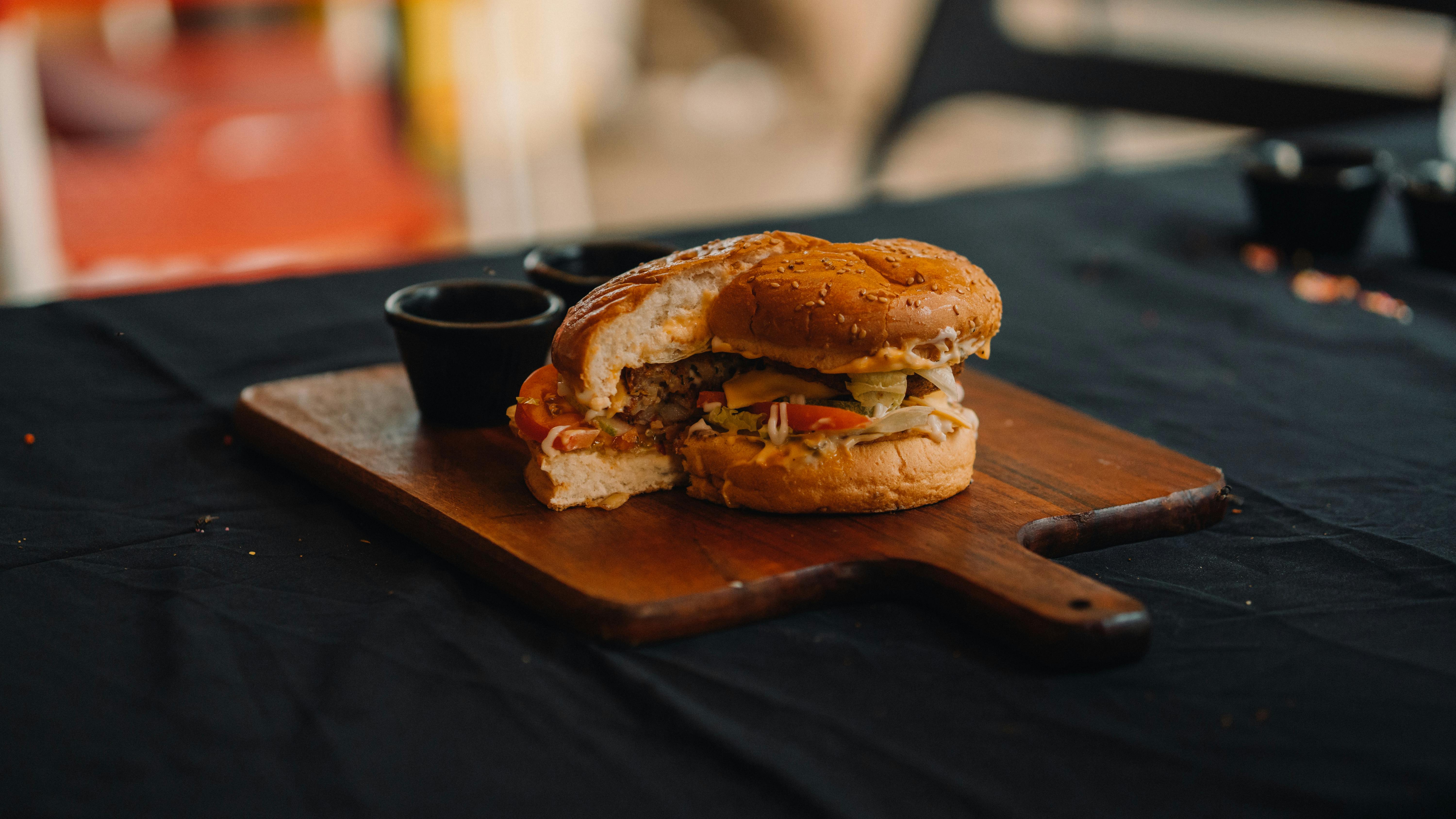 Burger on Brown Wooden Chopping Board · Free Stock Photo