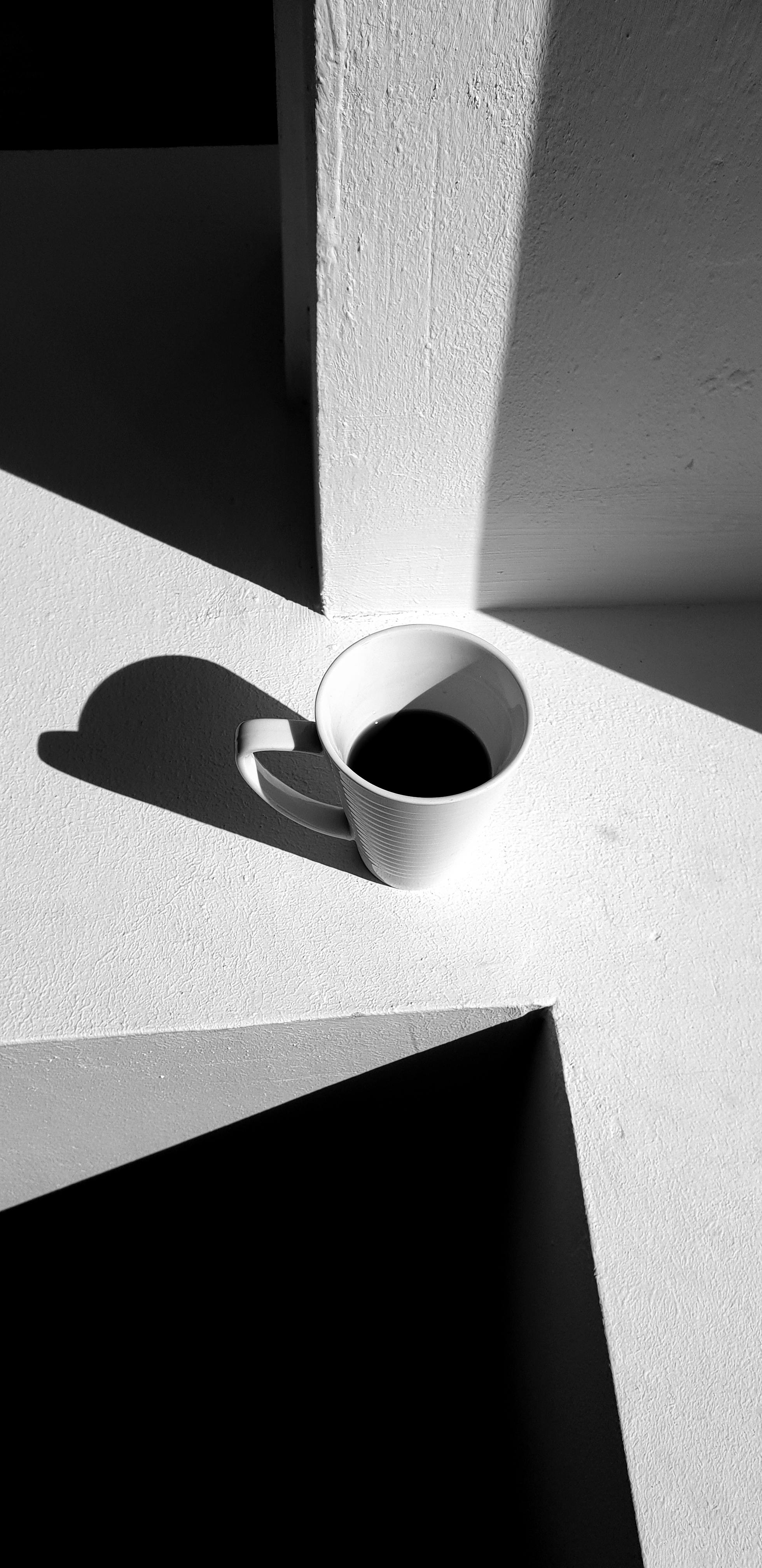 A Grayscale of Spilled Coffee Beans from a Mug · Free Stock Photo