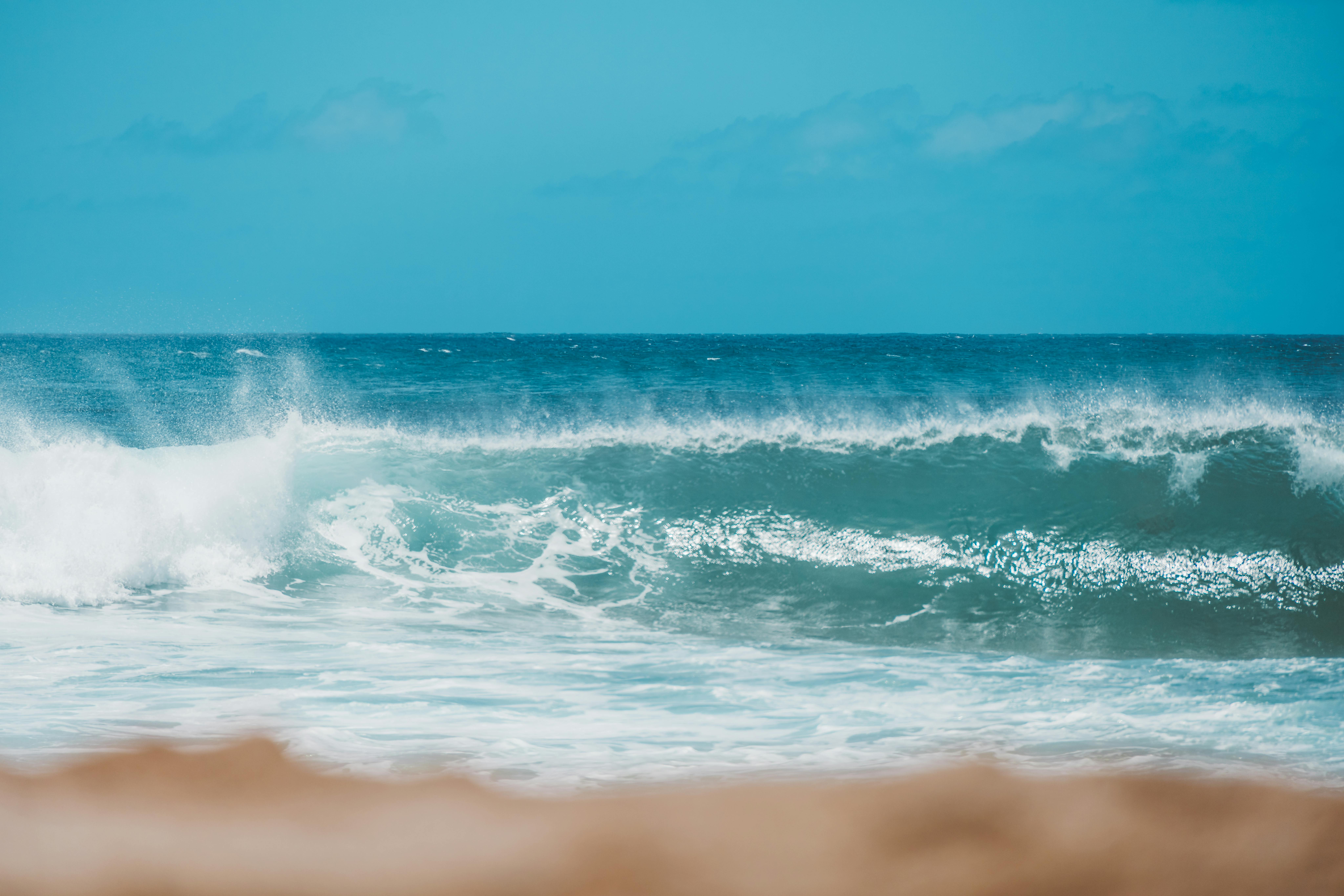 Ocean Waves near the Shore Under Blue Sky · Free Stock Photo