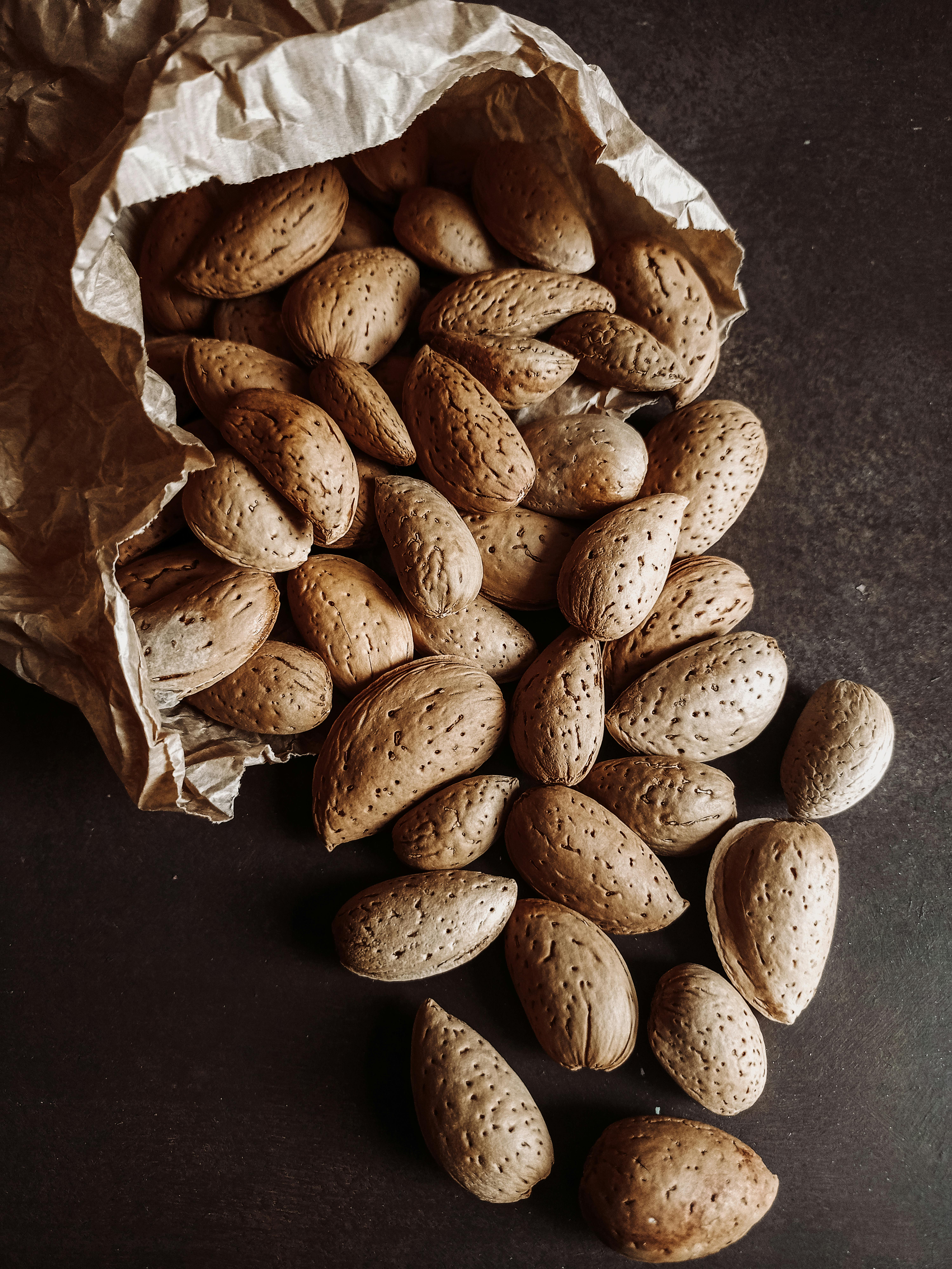 Shelled Almonds on Black Surface · Free Stock Photo