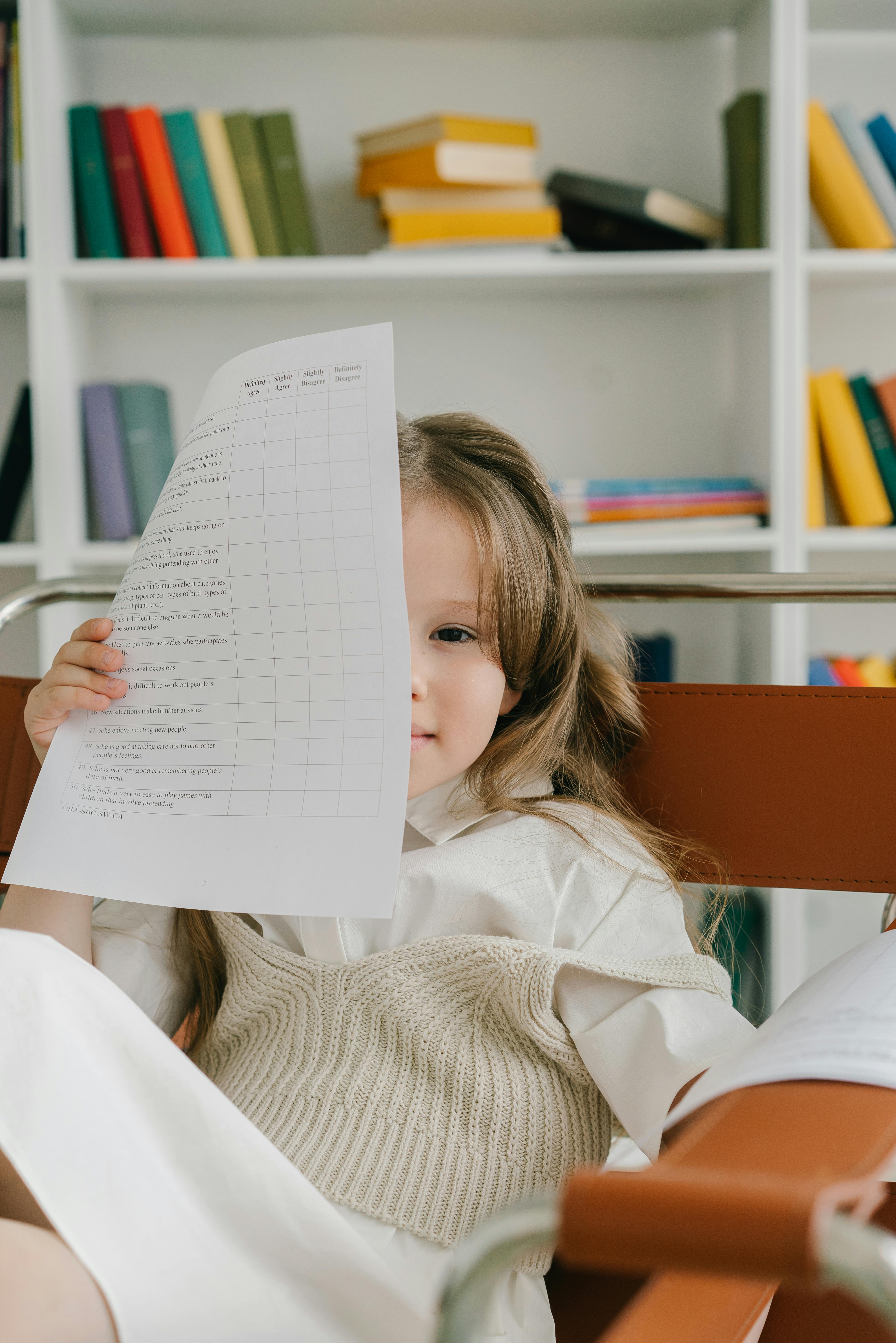 Photograph of a Child Holding a White Piece of Paper · Free Stock Photo