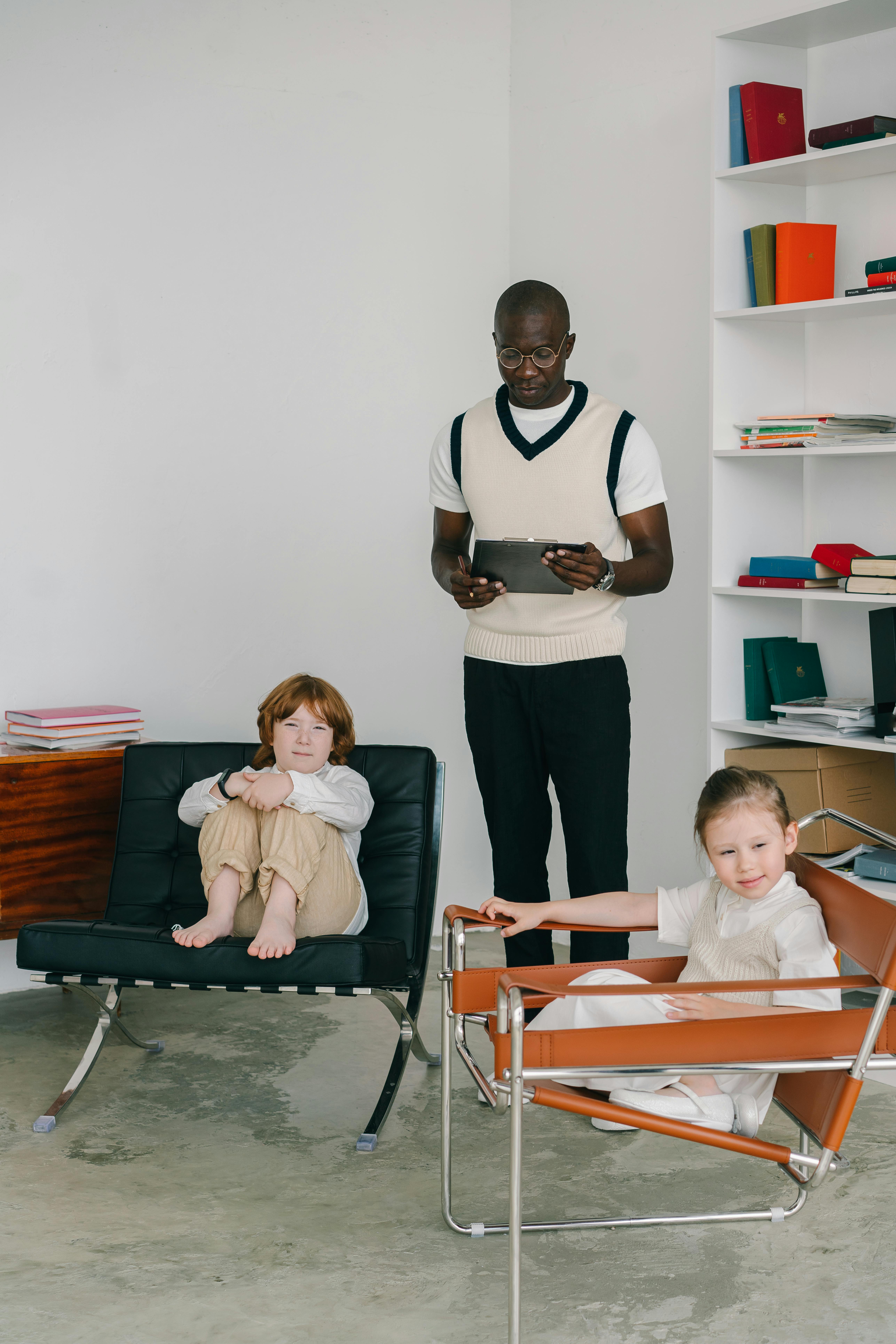 Psychologist standing between Two Children · Free Stock Photo