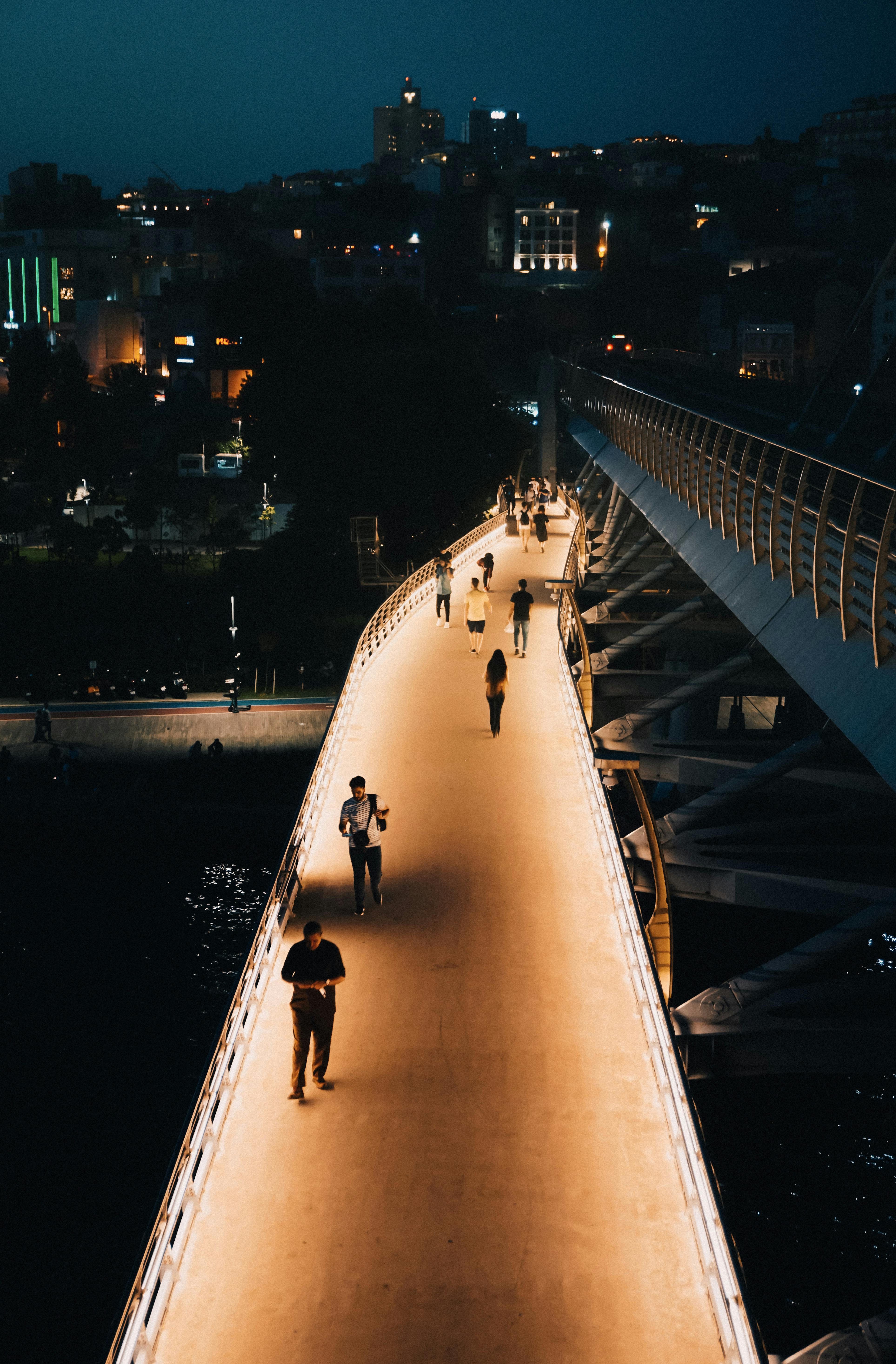 Illuminated Sign on Building near Bridge above River · Free Stock Photo