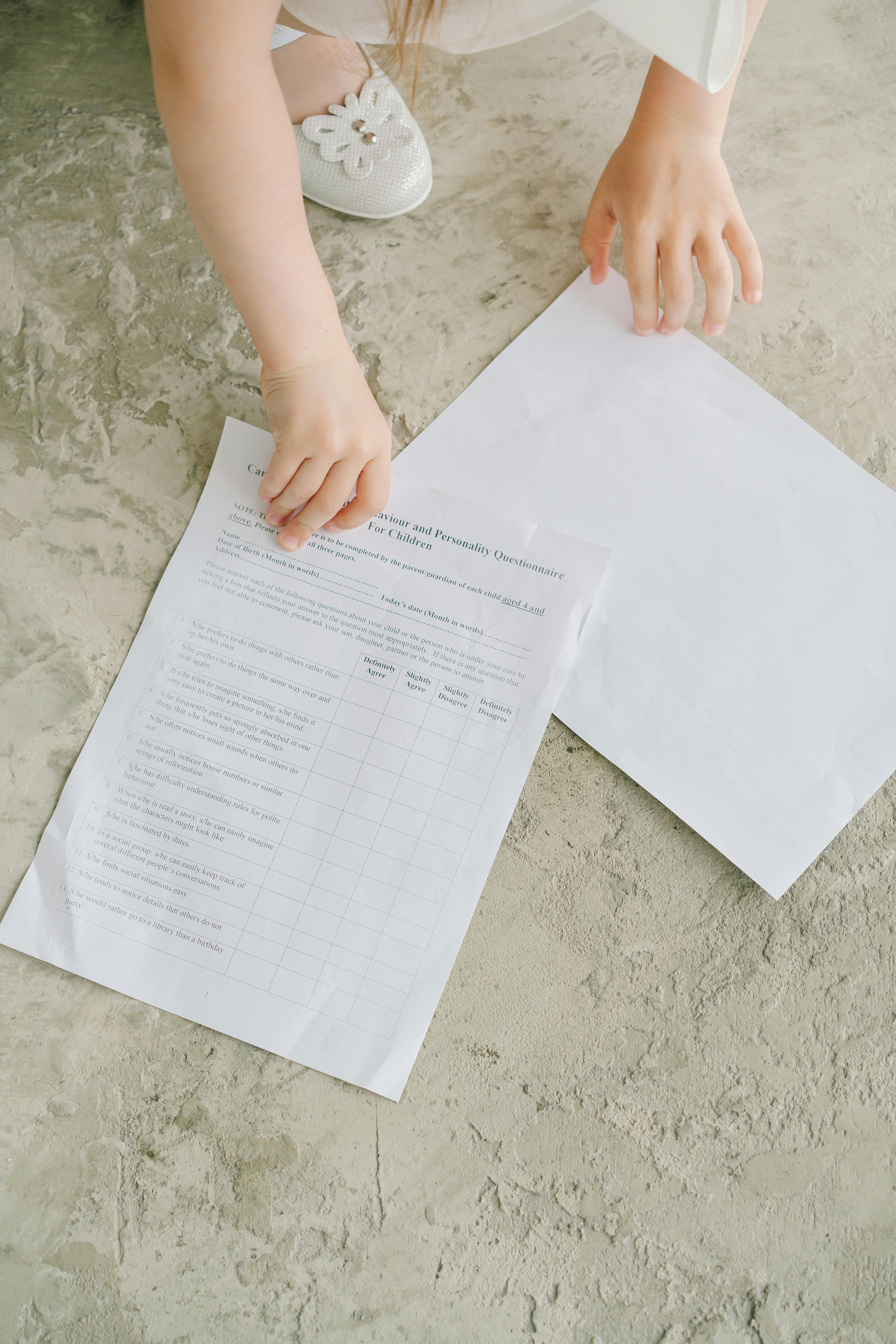 A Person Picking the Papers on the Floor · Free Stock Photo