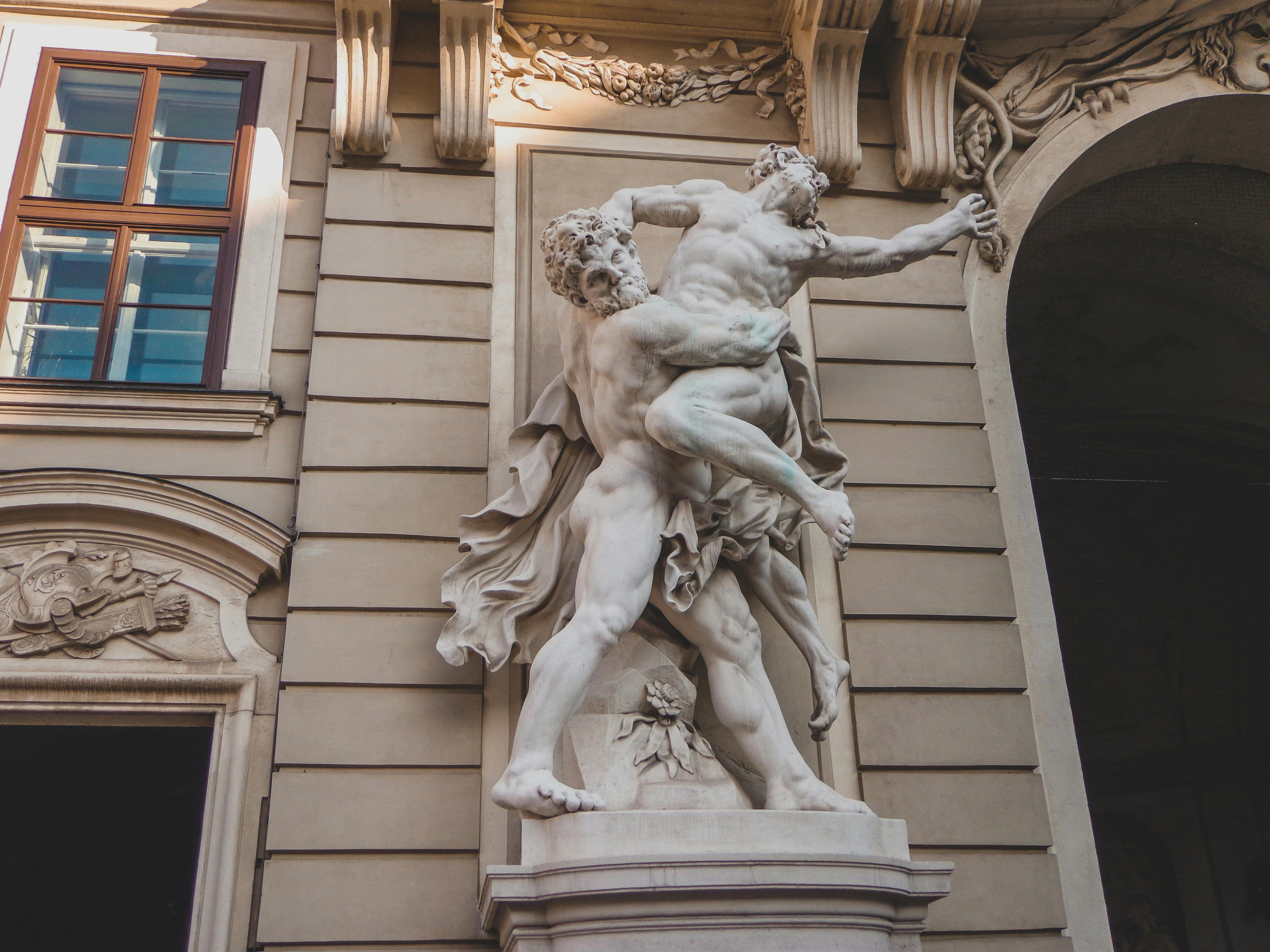 A Concrete Statue of Two Men · Free Stock Photo