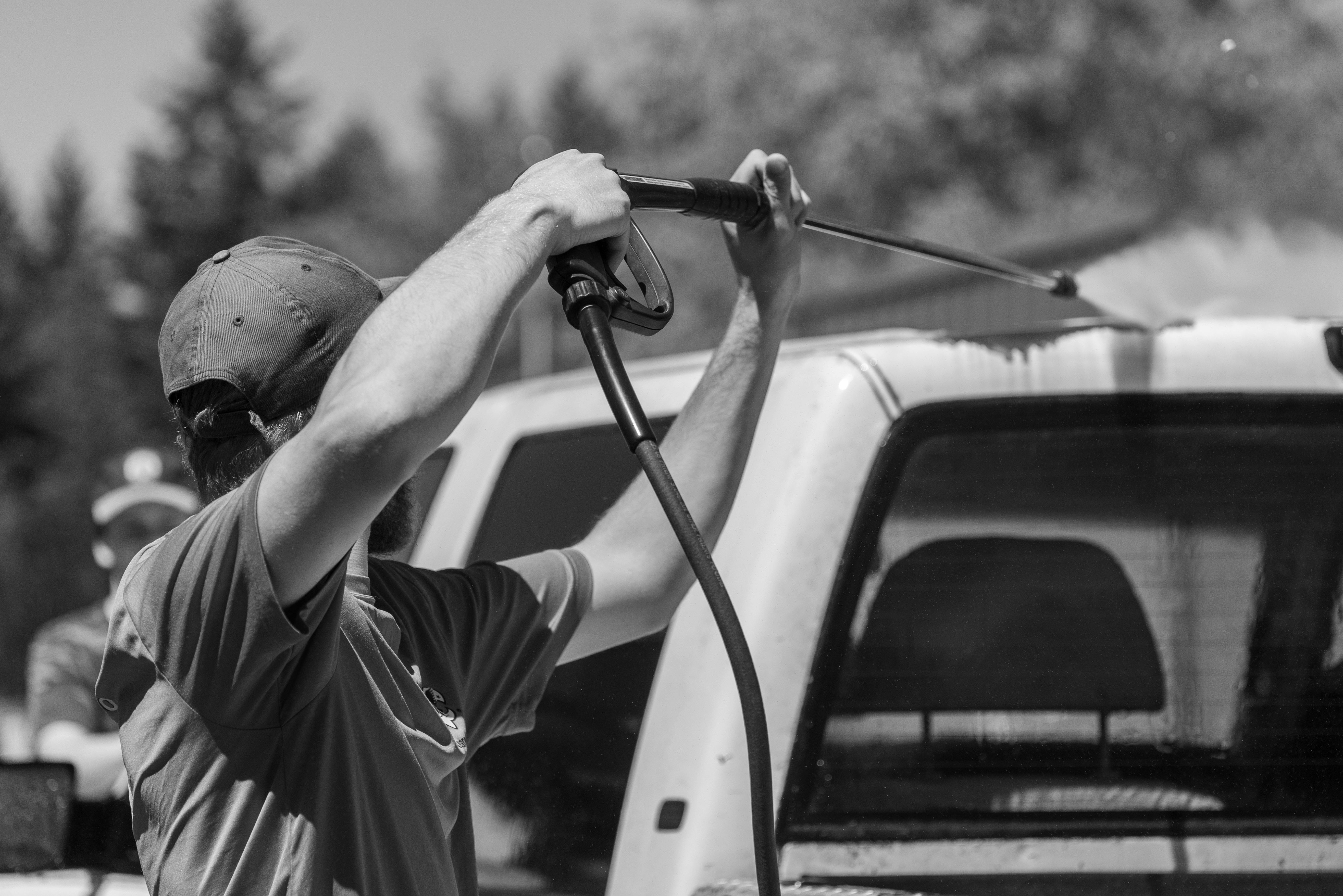 A Man Spraying His Car with Water · Free Stock Photo