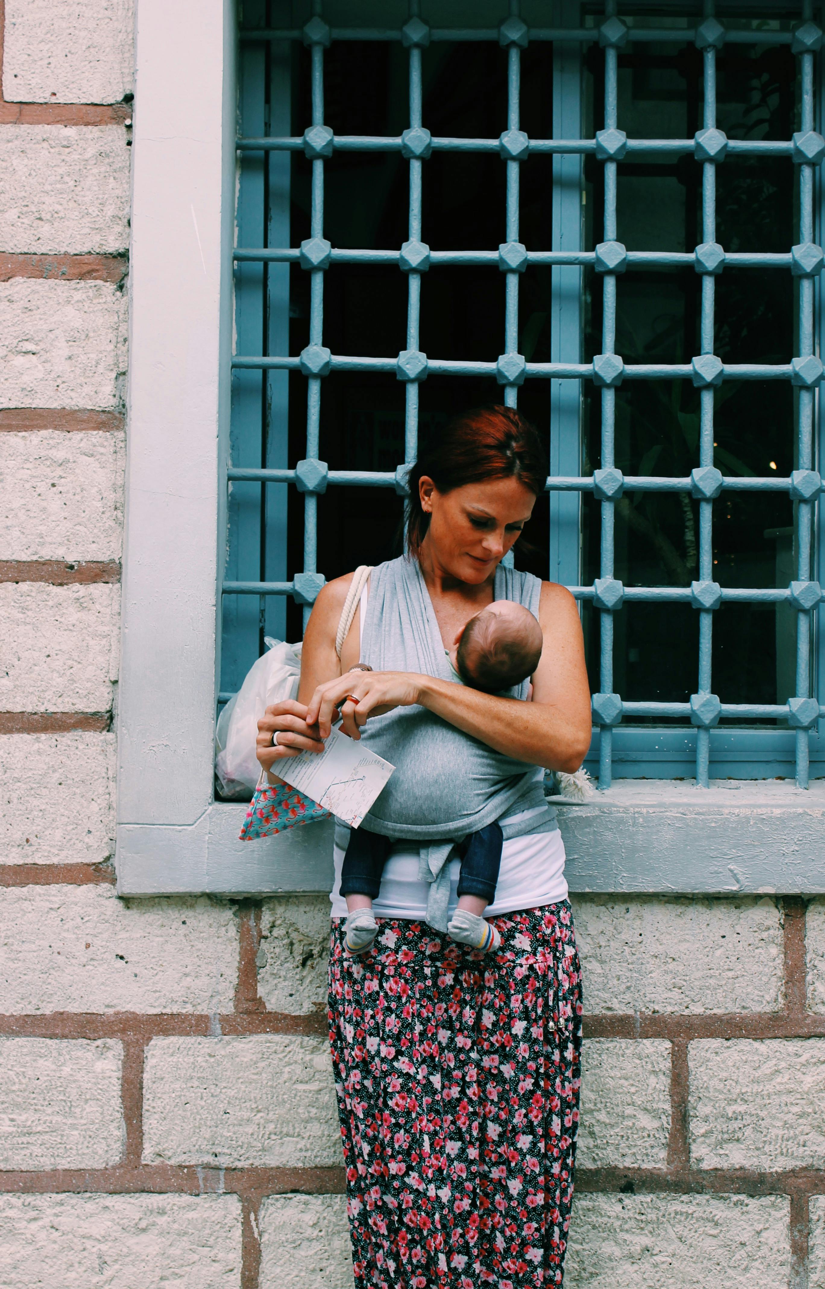 A Woman Carrying a Baby · Free Stock Photo