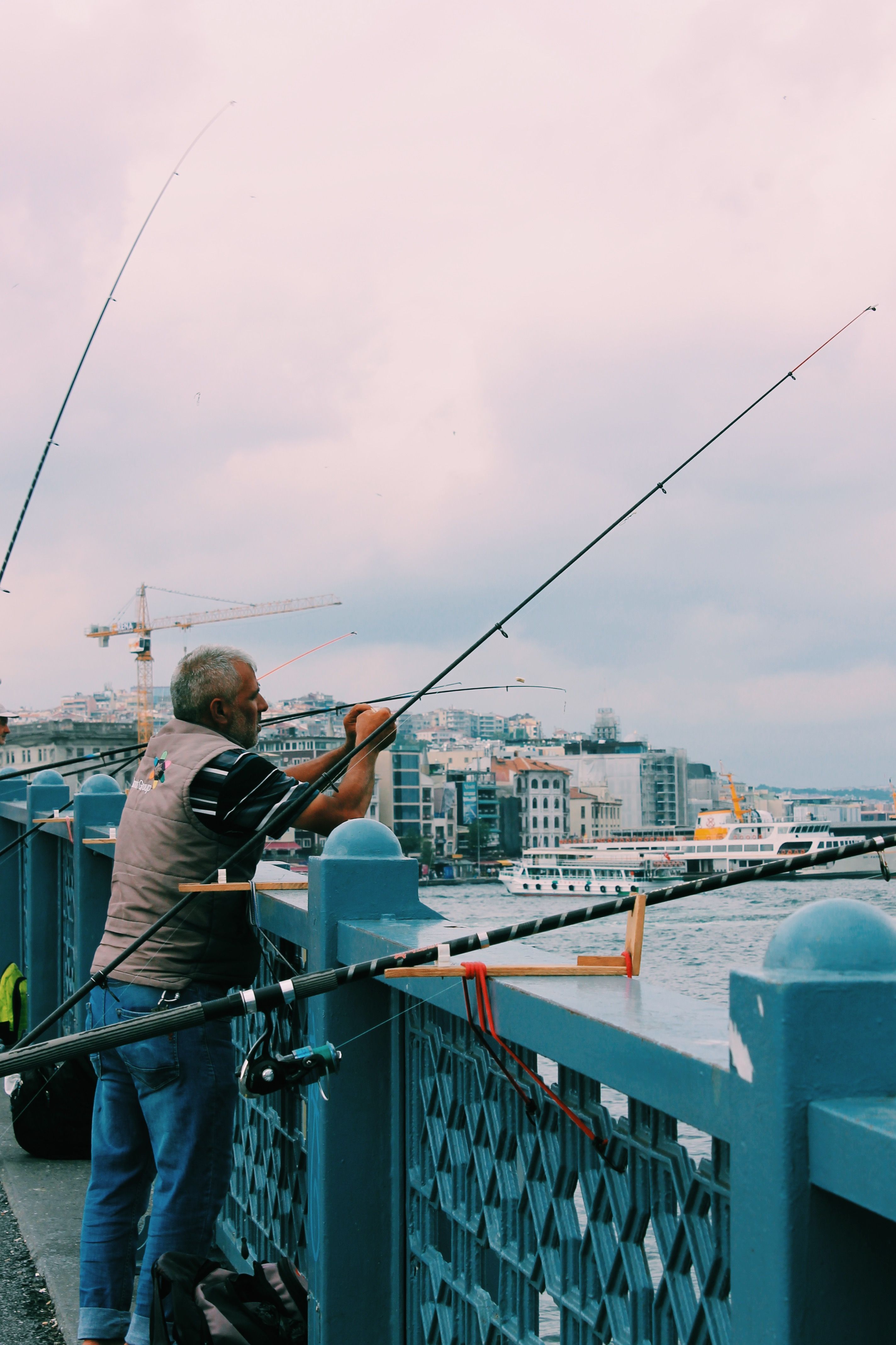 A Man Holding a Fishing Rod · Free Stock Photo