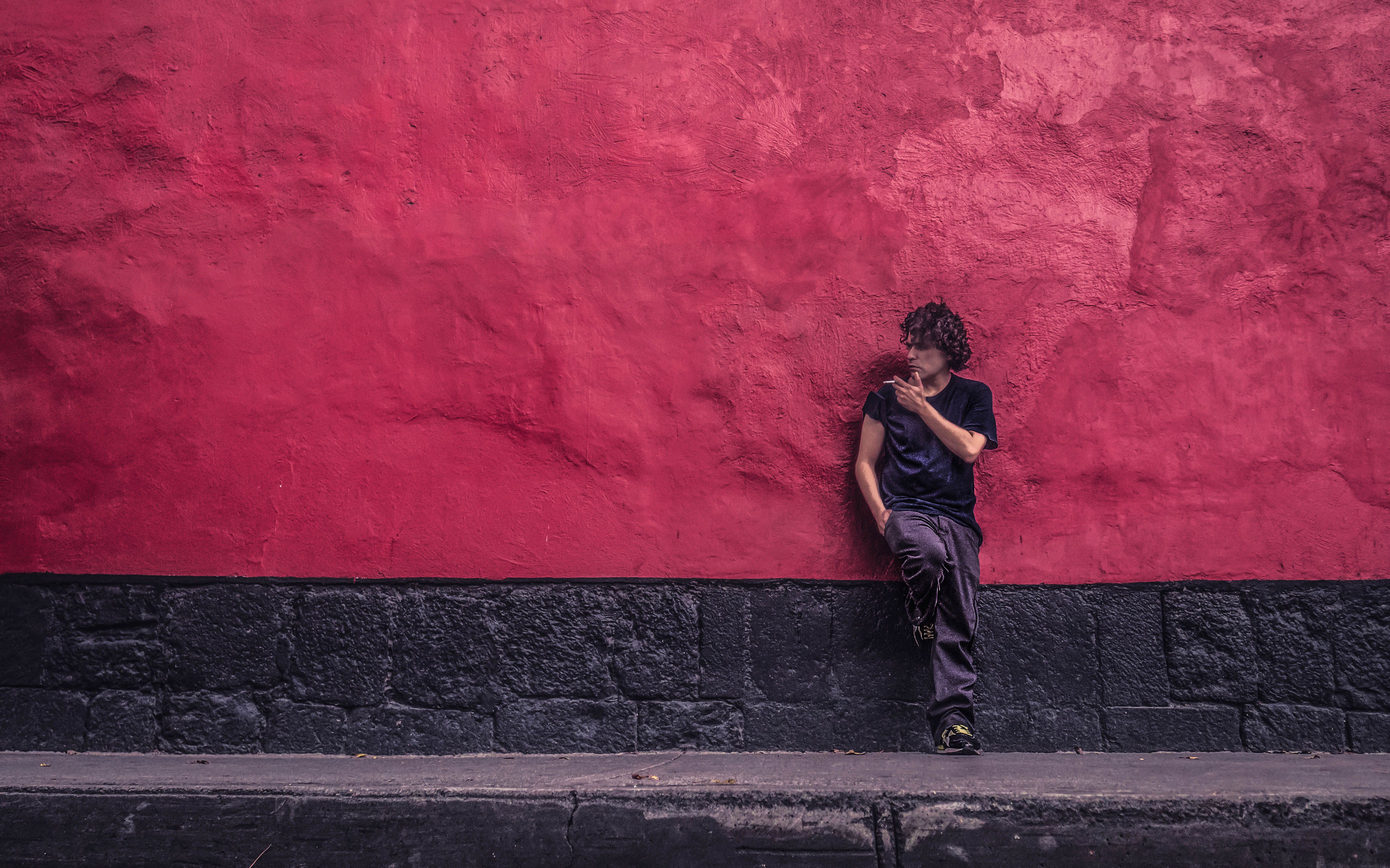 Man Leaning on Wall Smoking · Free Stock Photo