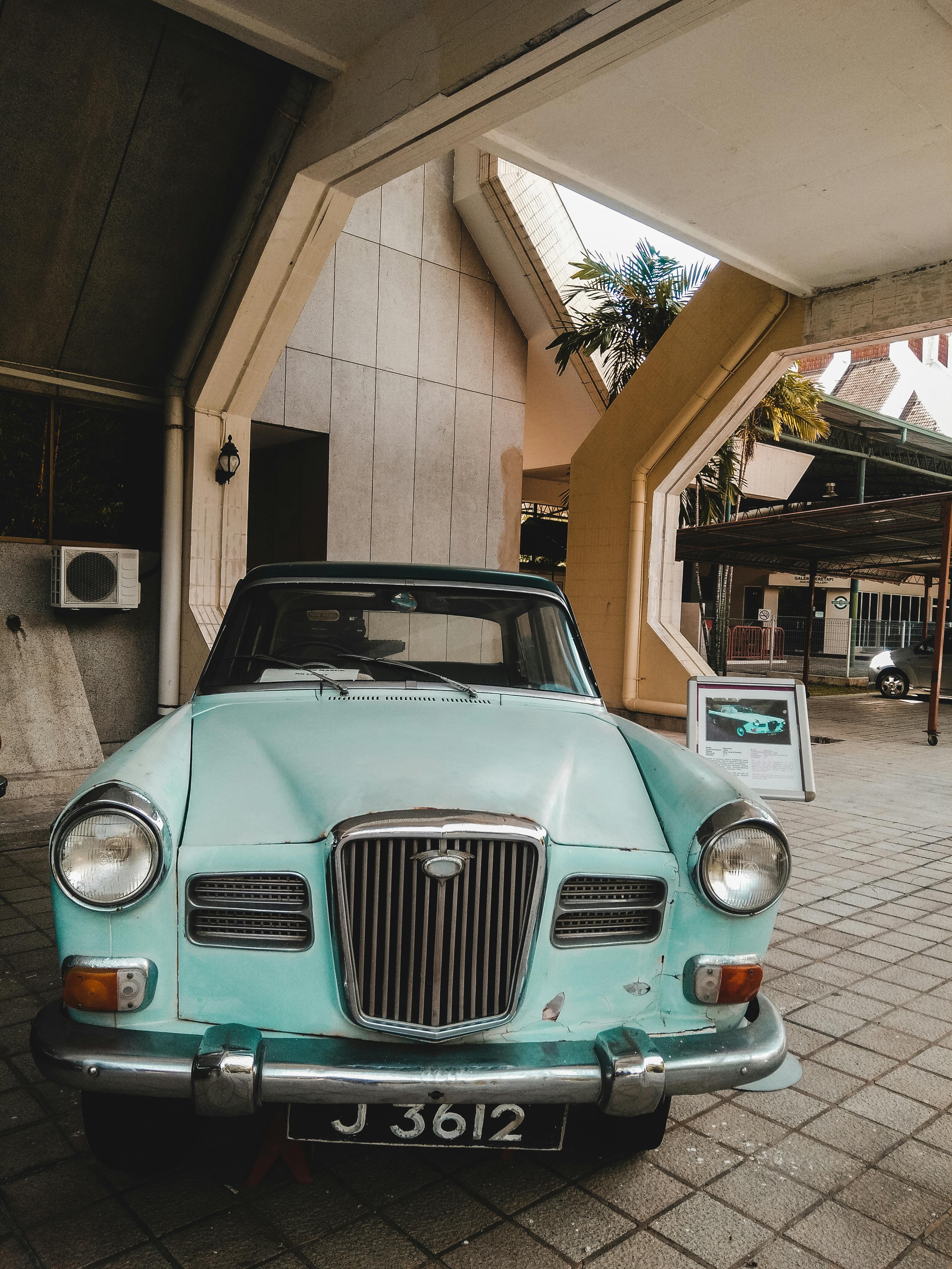 Blue Car Parked Beside a Building · Free Stock Photo